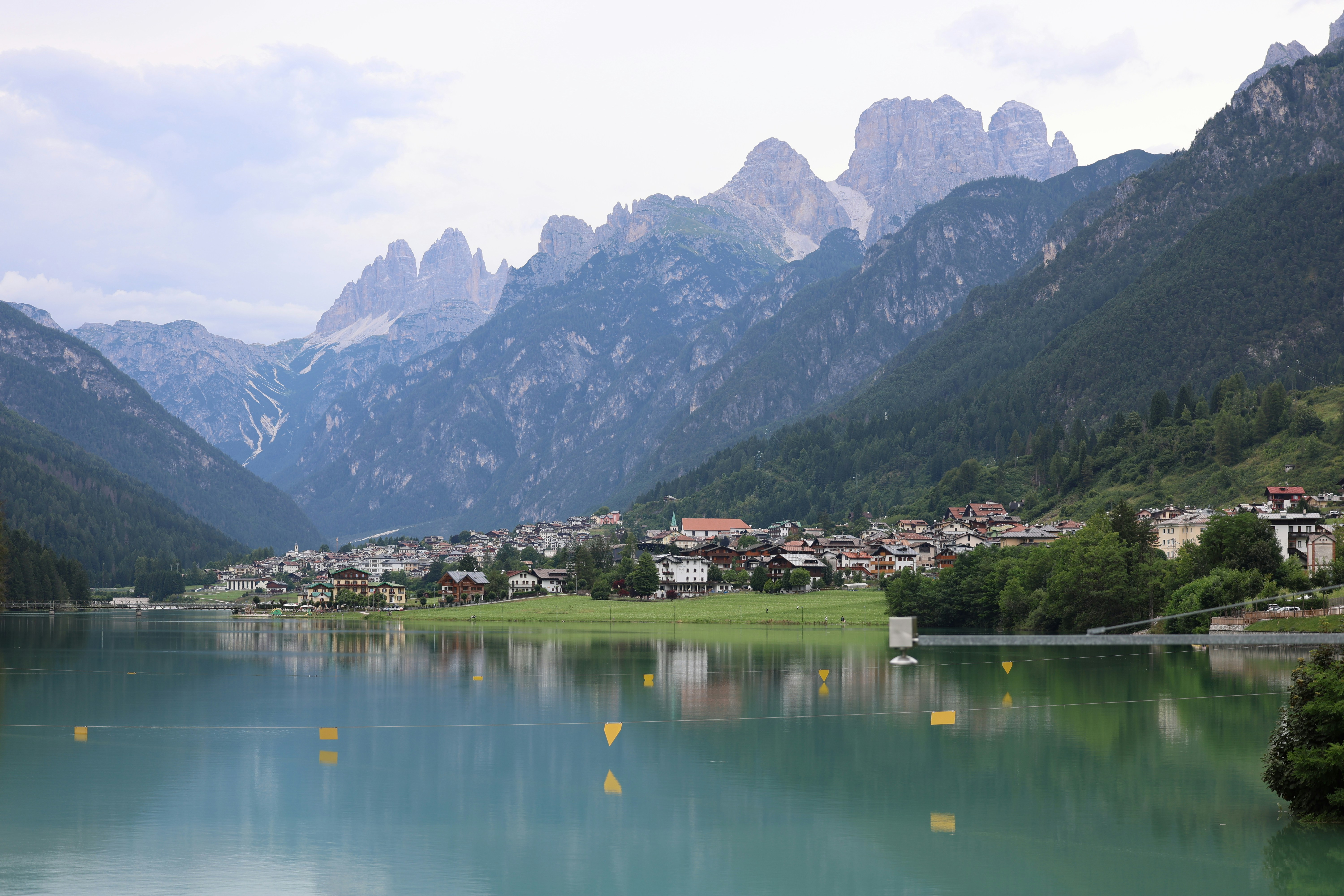 Alpine Village Framed by Majestic Peaks Over a Serene Lake