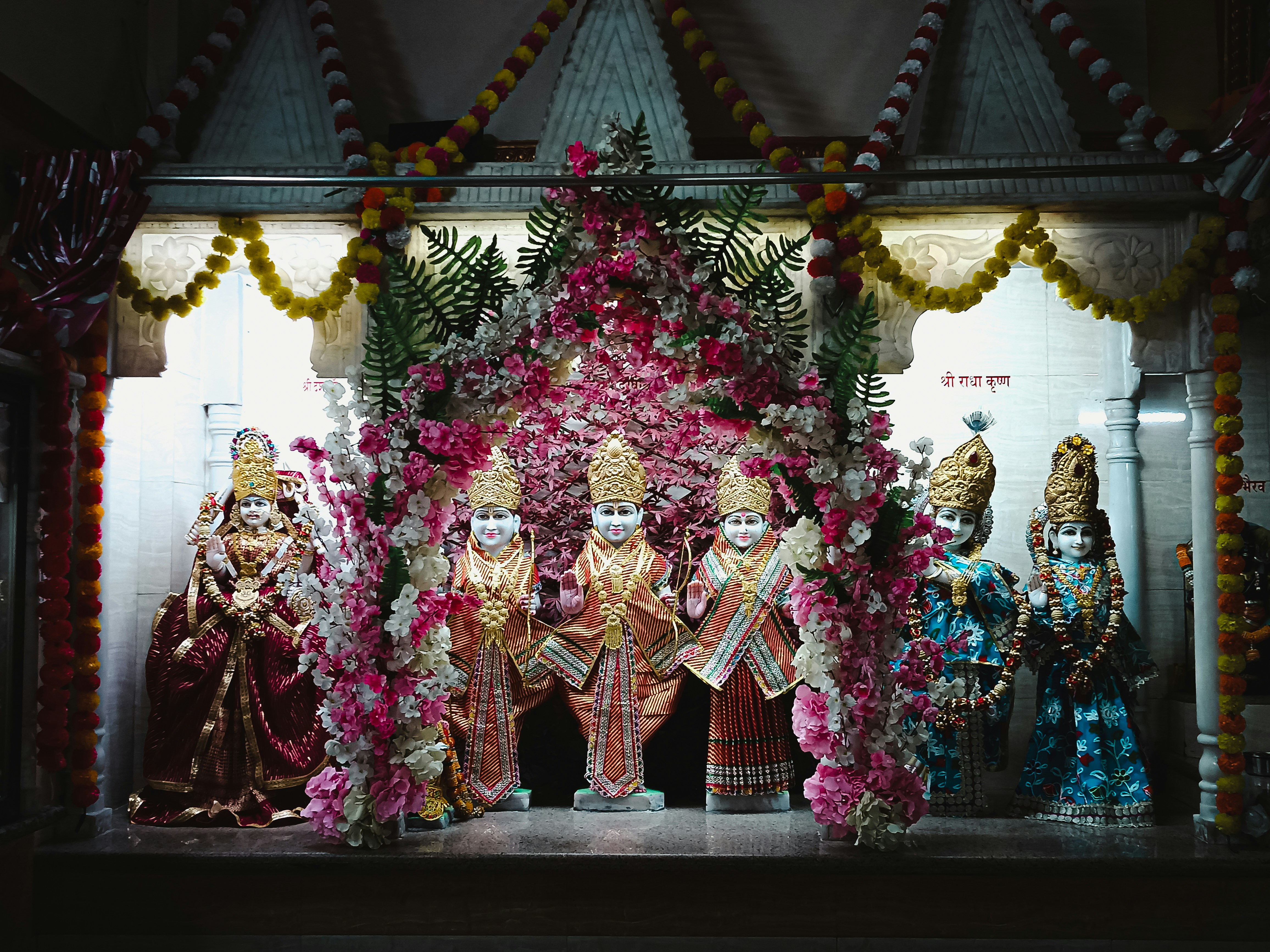 A group of statues sitting on top of a stage photo – Free Sacred love ...