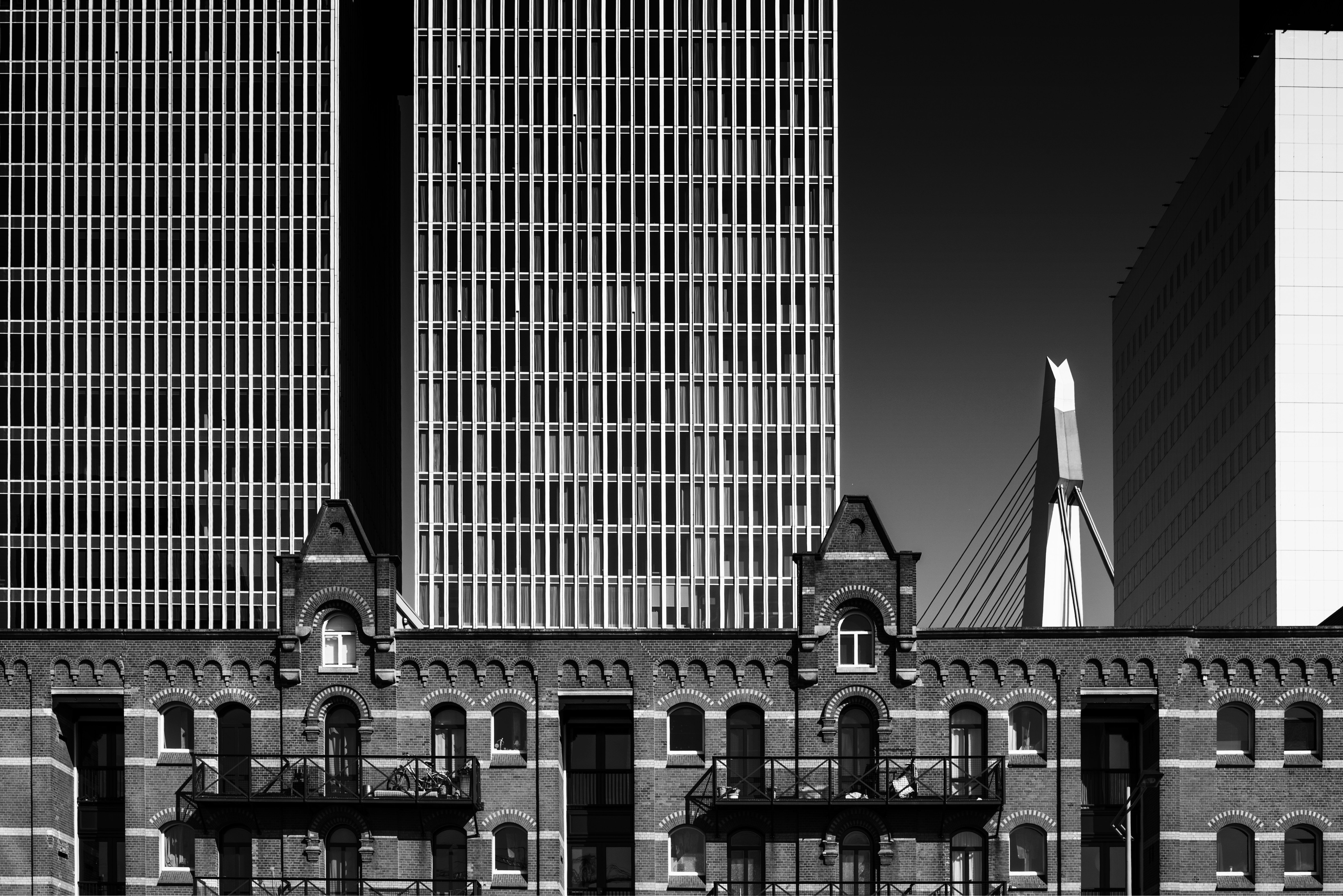 Brickwork Against Glass Giants: A Monochrome Cityscape