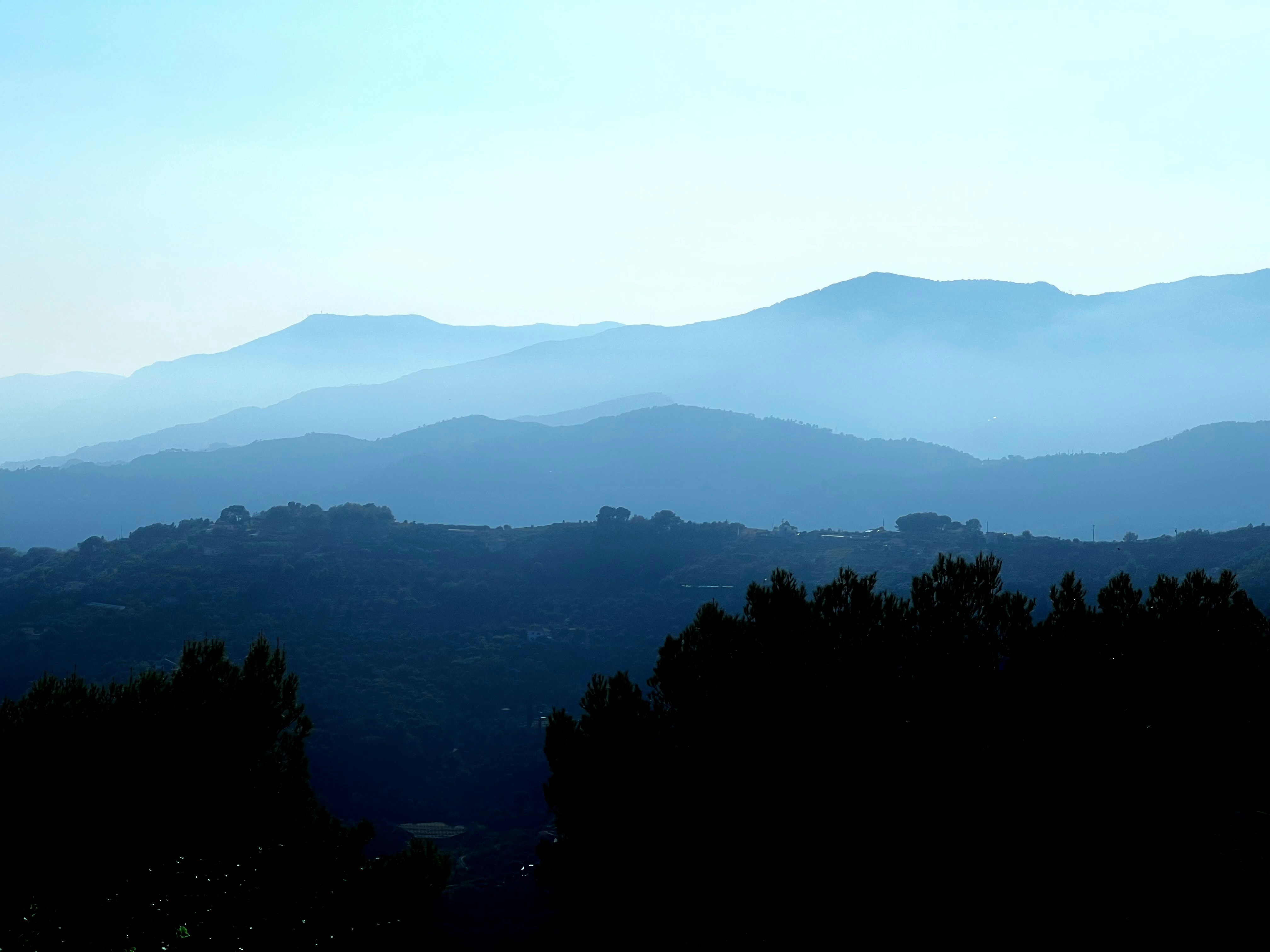 Blue-Tinted Horizon: Layered Ridges in Quiet Mountain Landscape