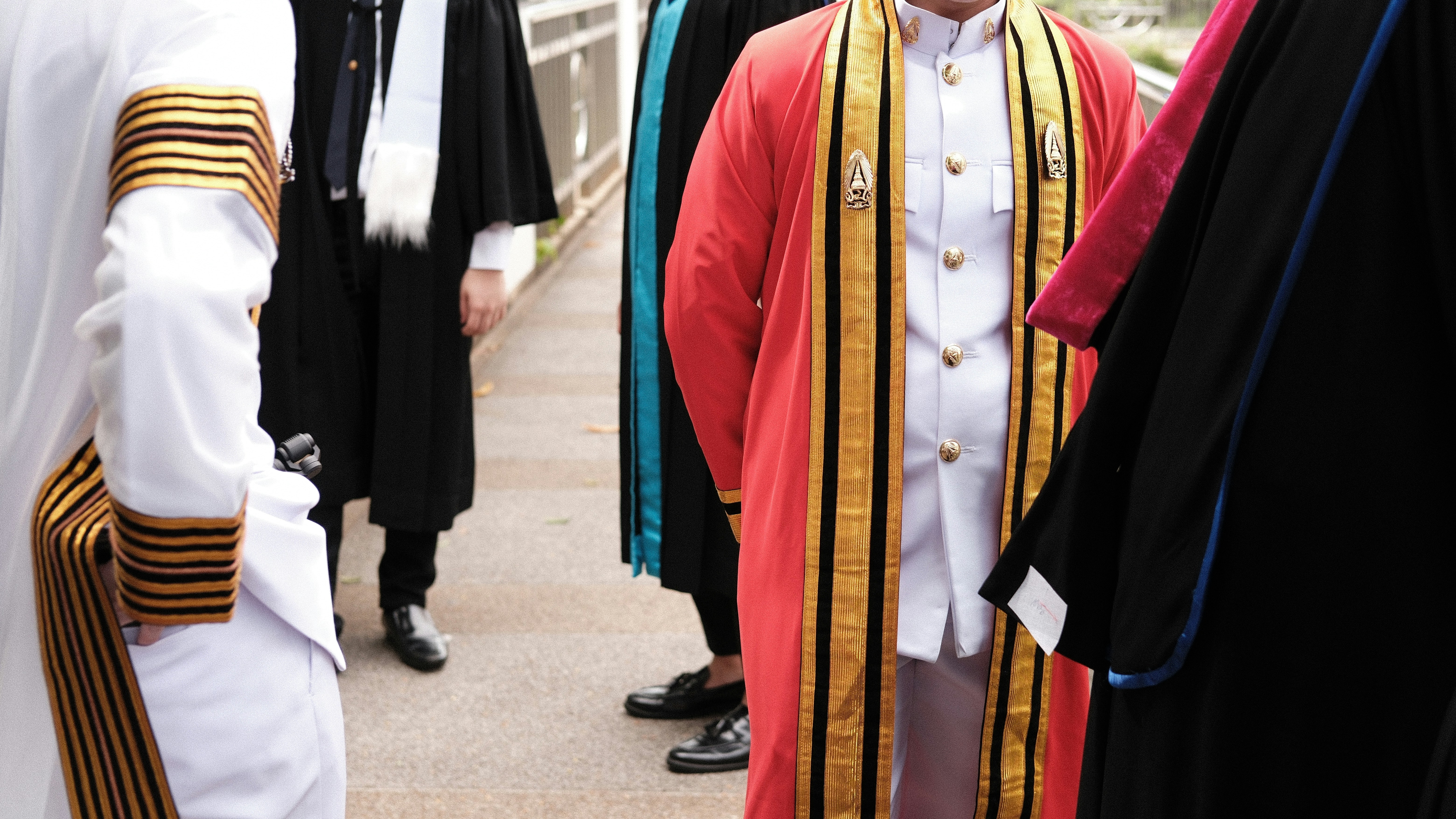 A group of men standing next to each other on a bridge