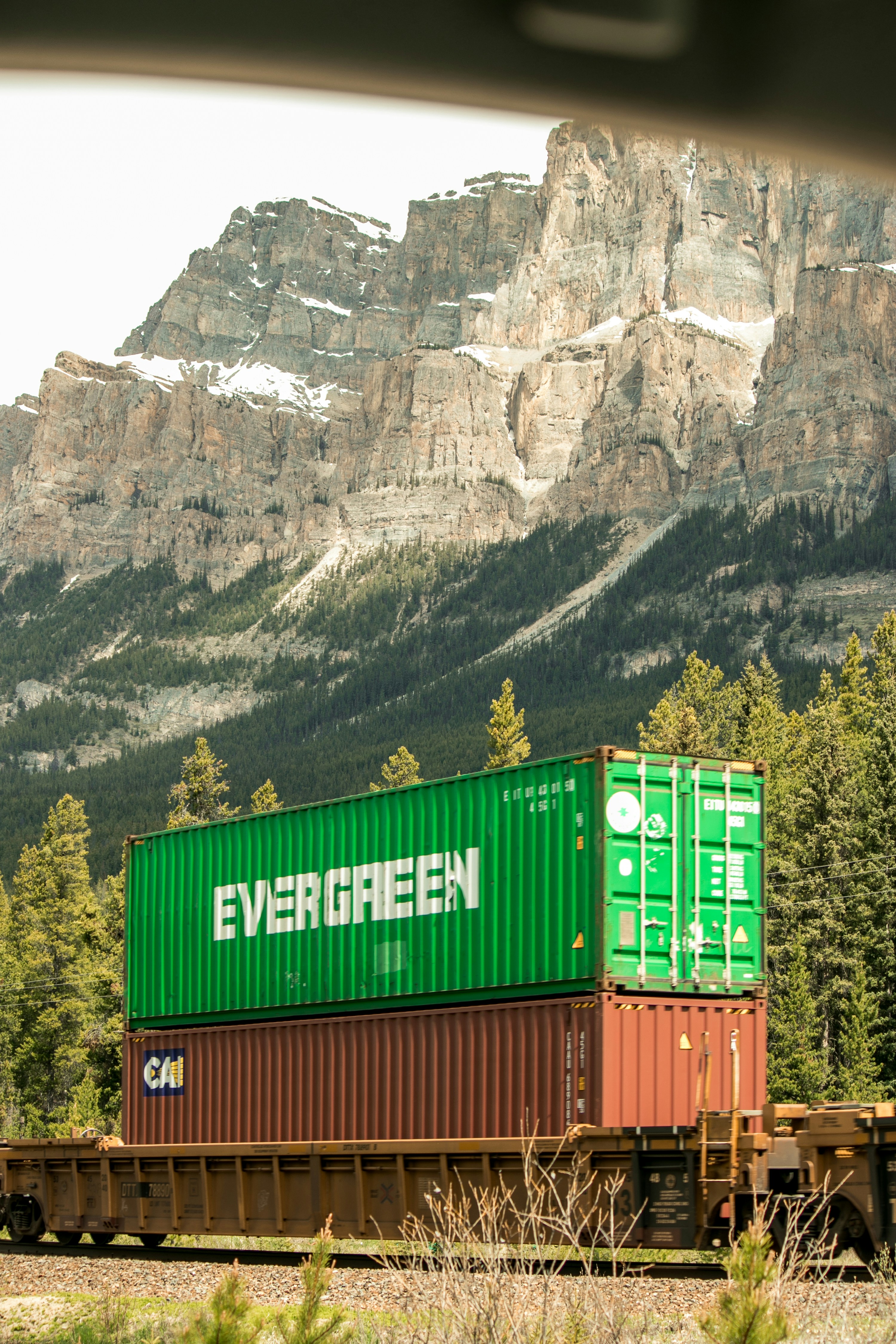 Green Freight Against a Rocky Backdrop