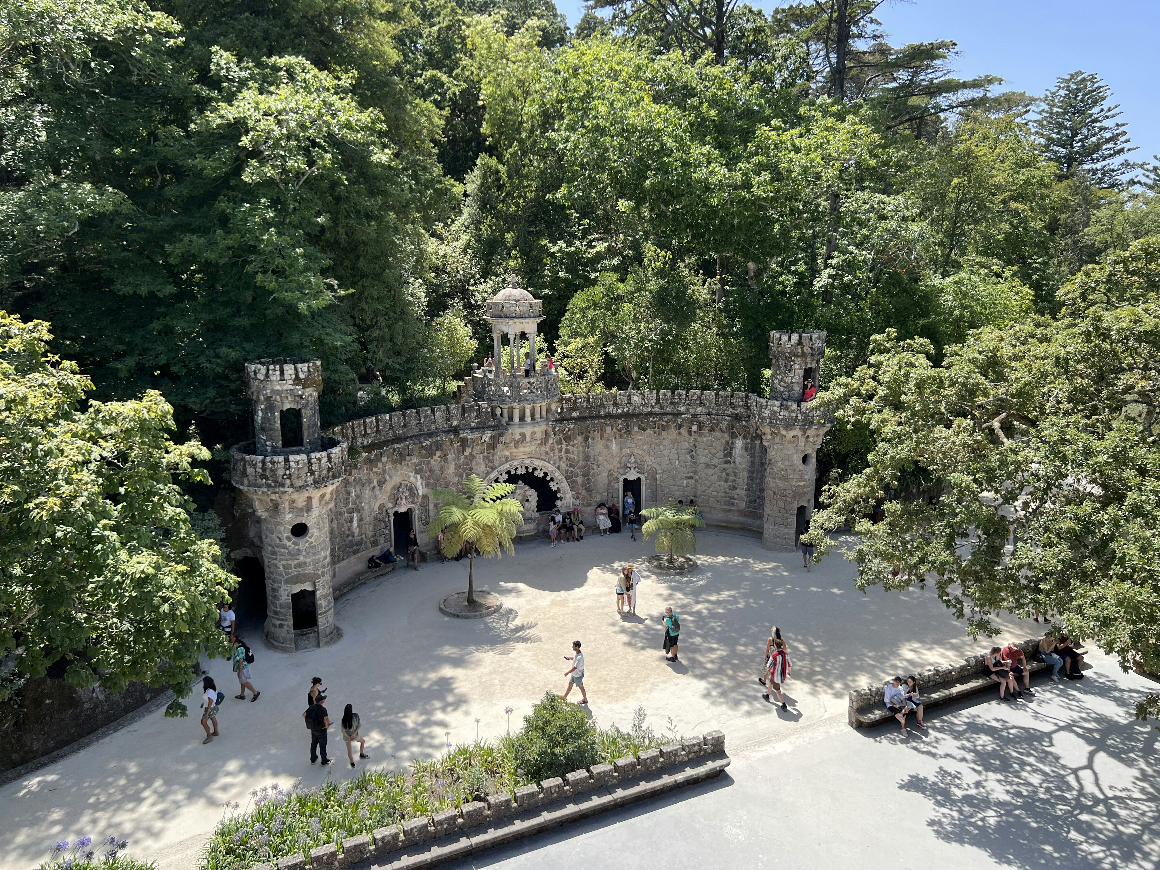 Sunlit Arc of Stone: A Historic Gate Framed by Forest CanopyWilliam V