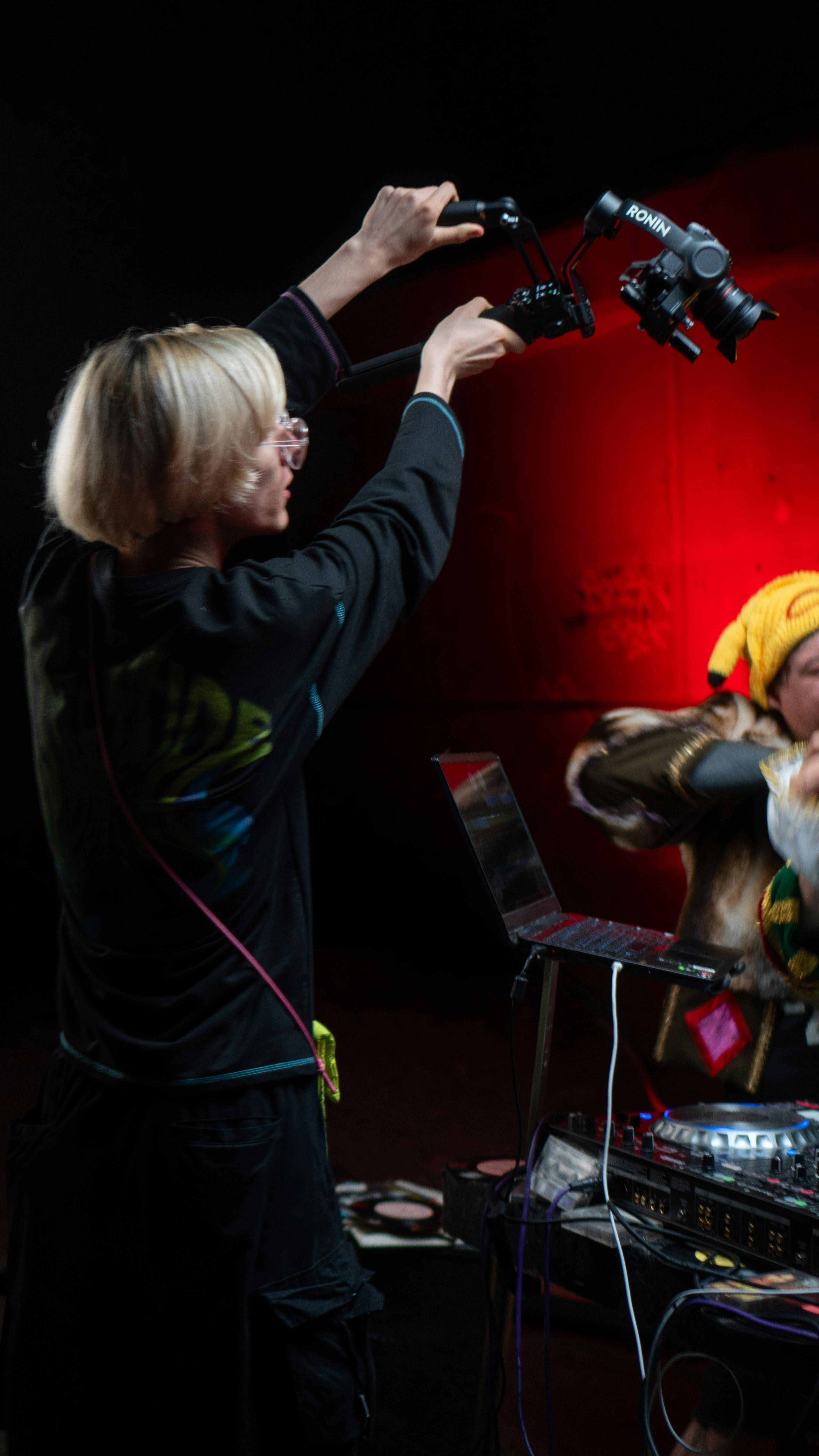 A group of people standing around a dj mixing photo – Free Portrait ...