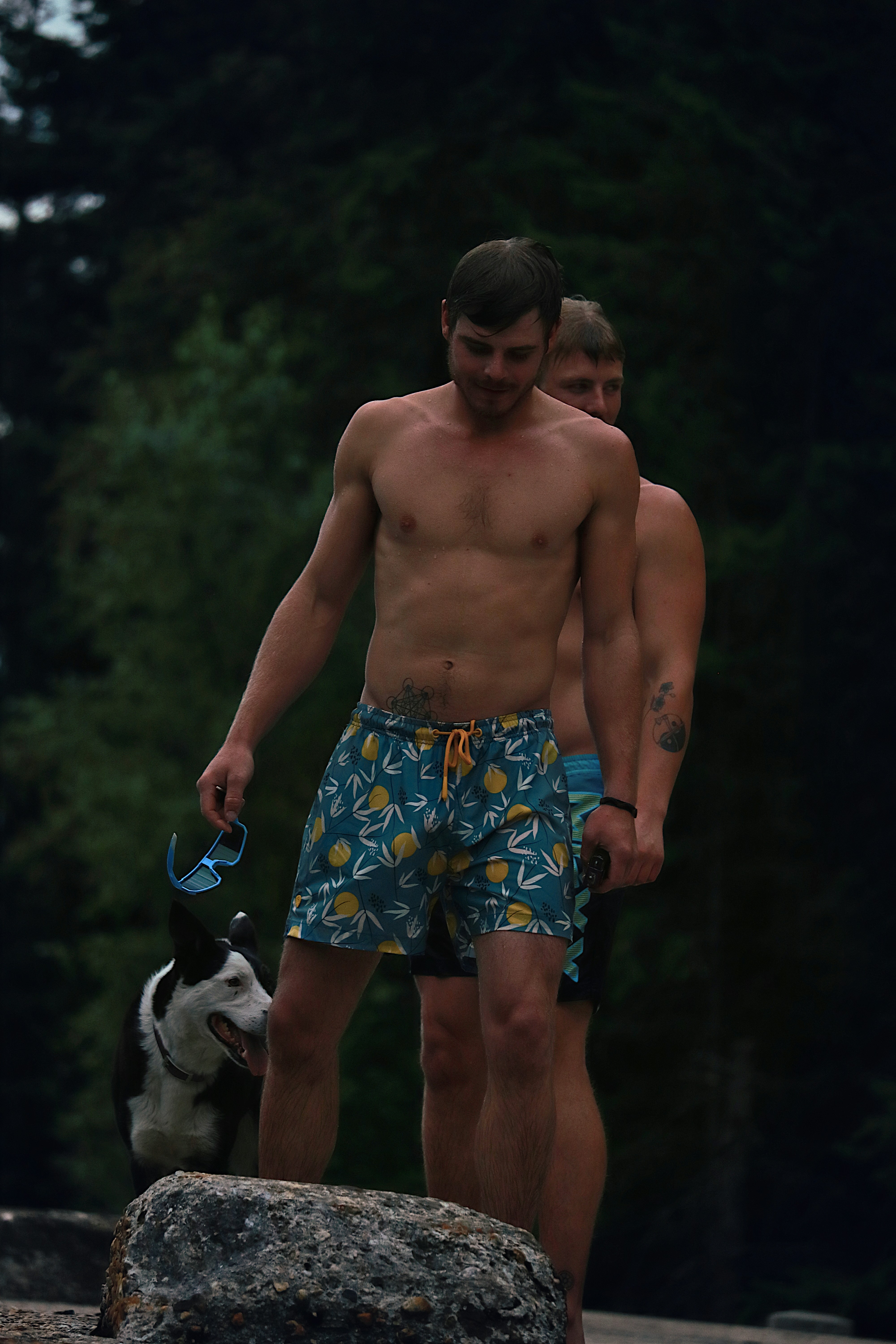 A shirtless man walking a dog on a leash photo – Free Man Image on Unsplash