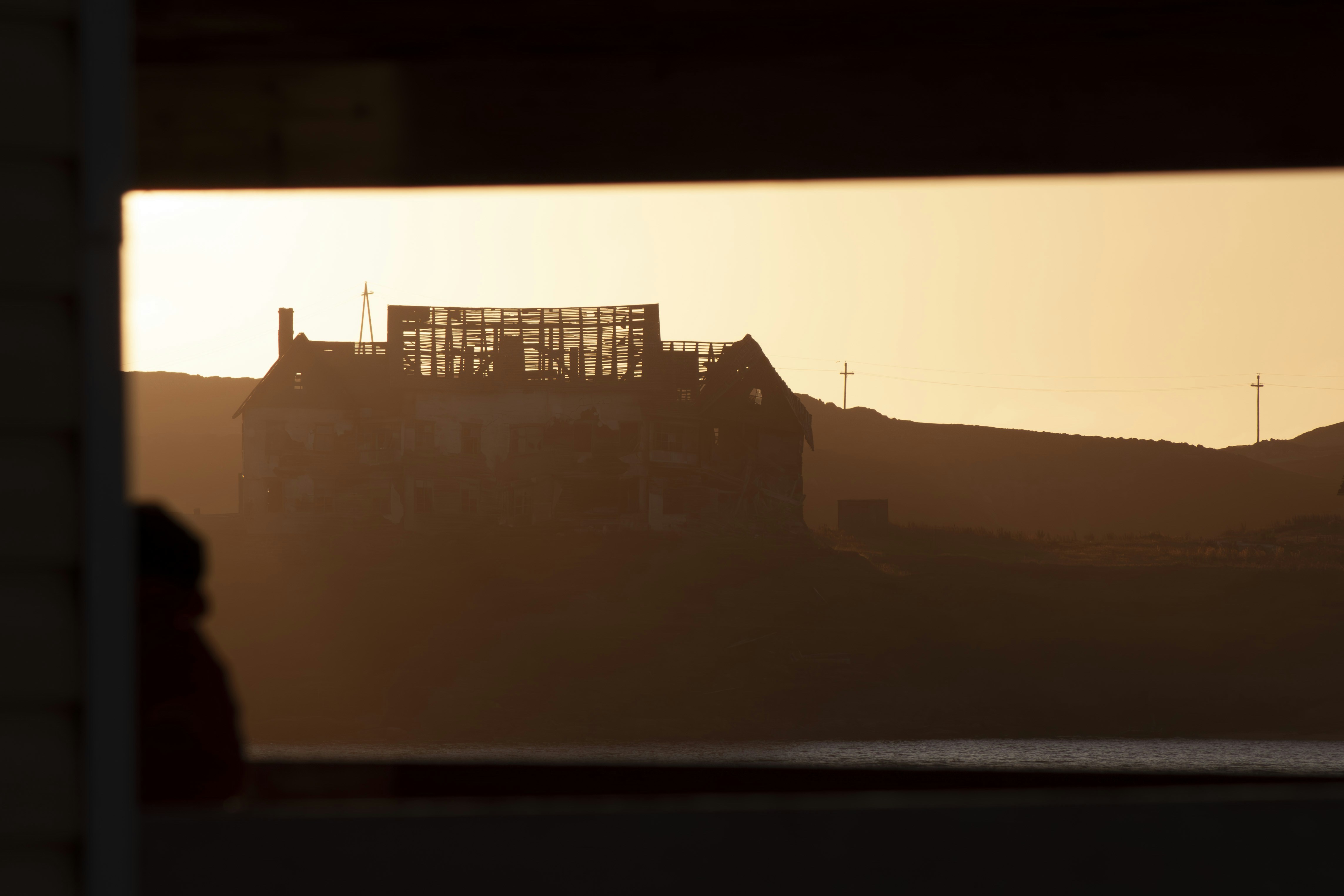 Silhouette of a burned-out building at golden hour