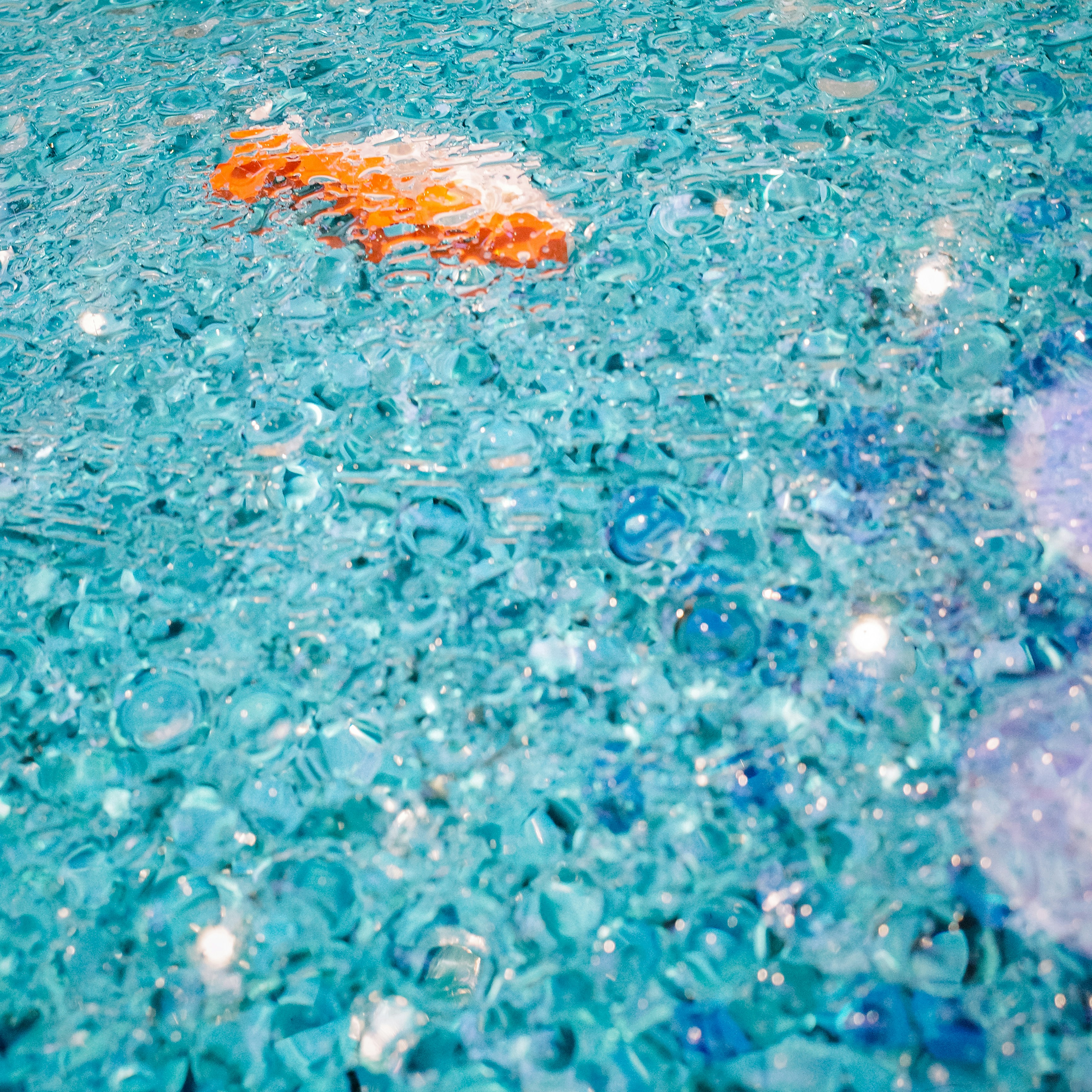 An orange object floating in a pool of water photo – Free Lego Image on ...