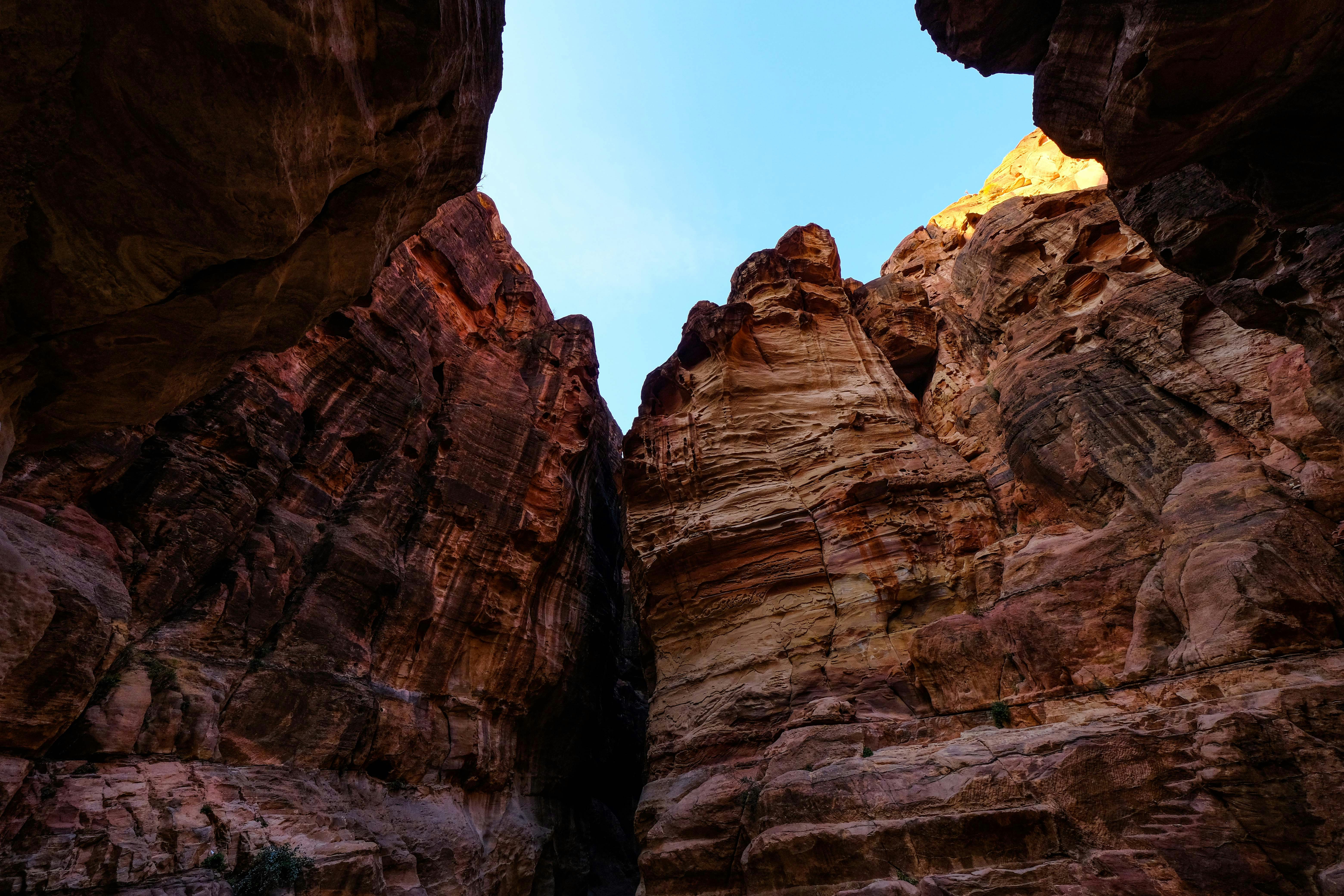 A view of a rock formation through a hole in the ground photo – Free ...