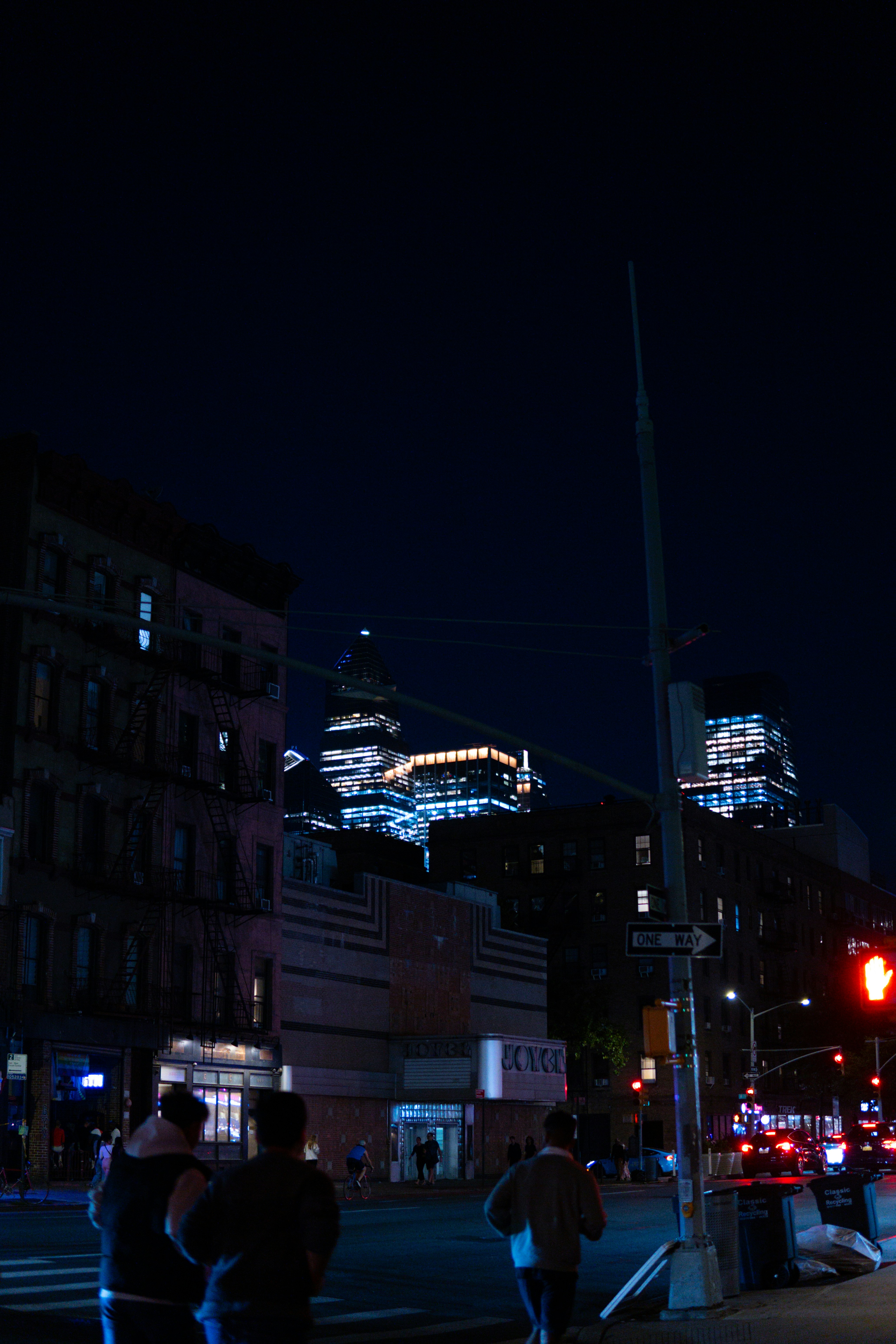 Distant Neon Peaks Over a Quiet Street at Night