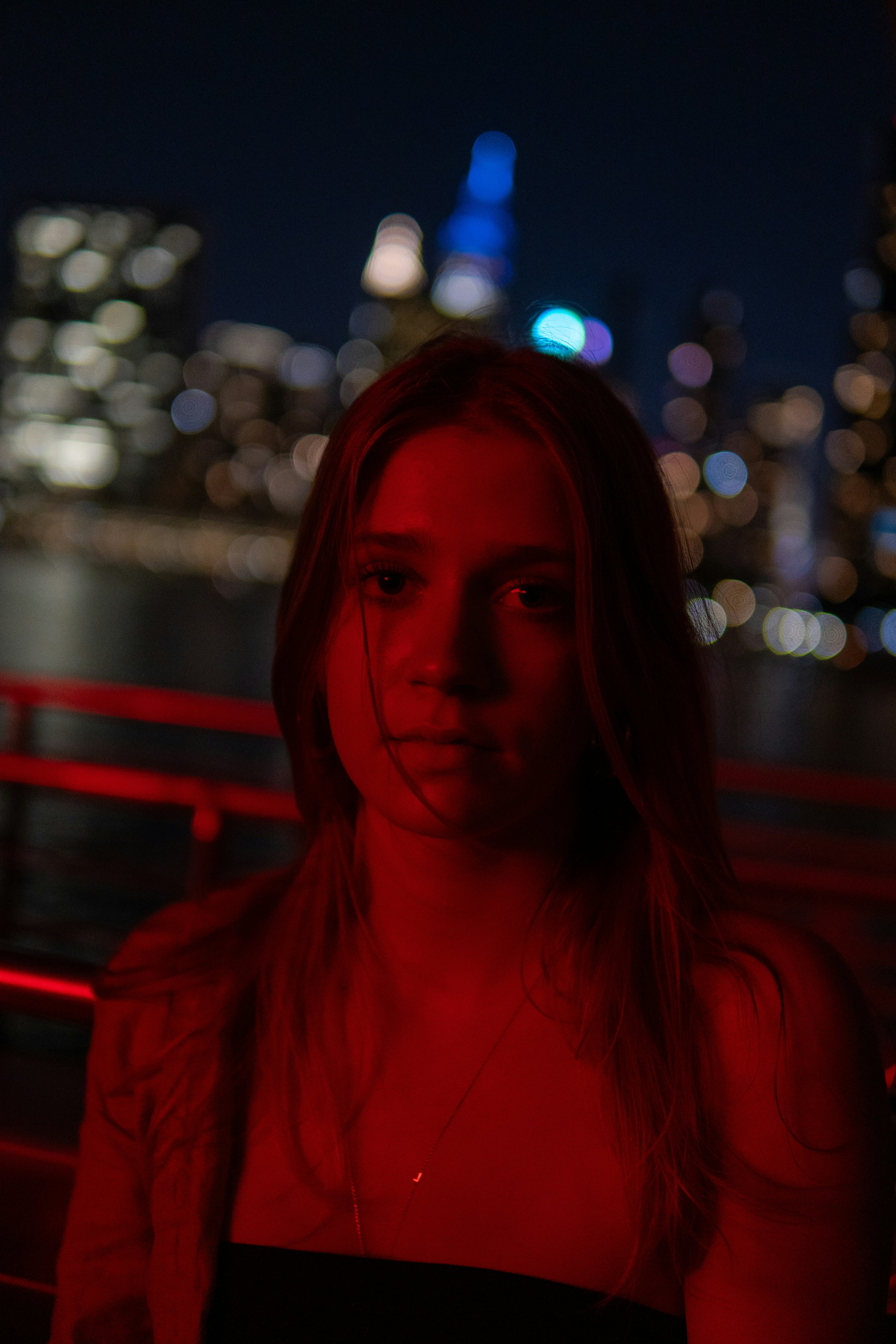 Crimson Night Portrait on a Waterfront Pier