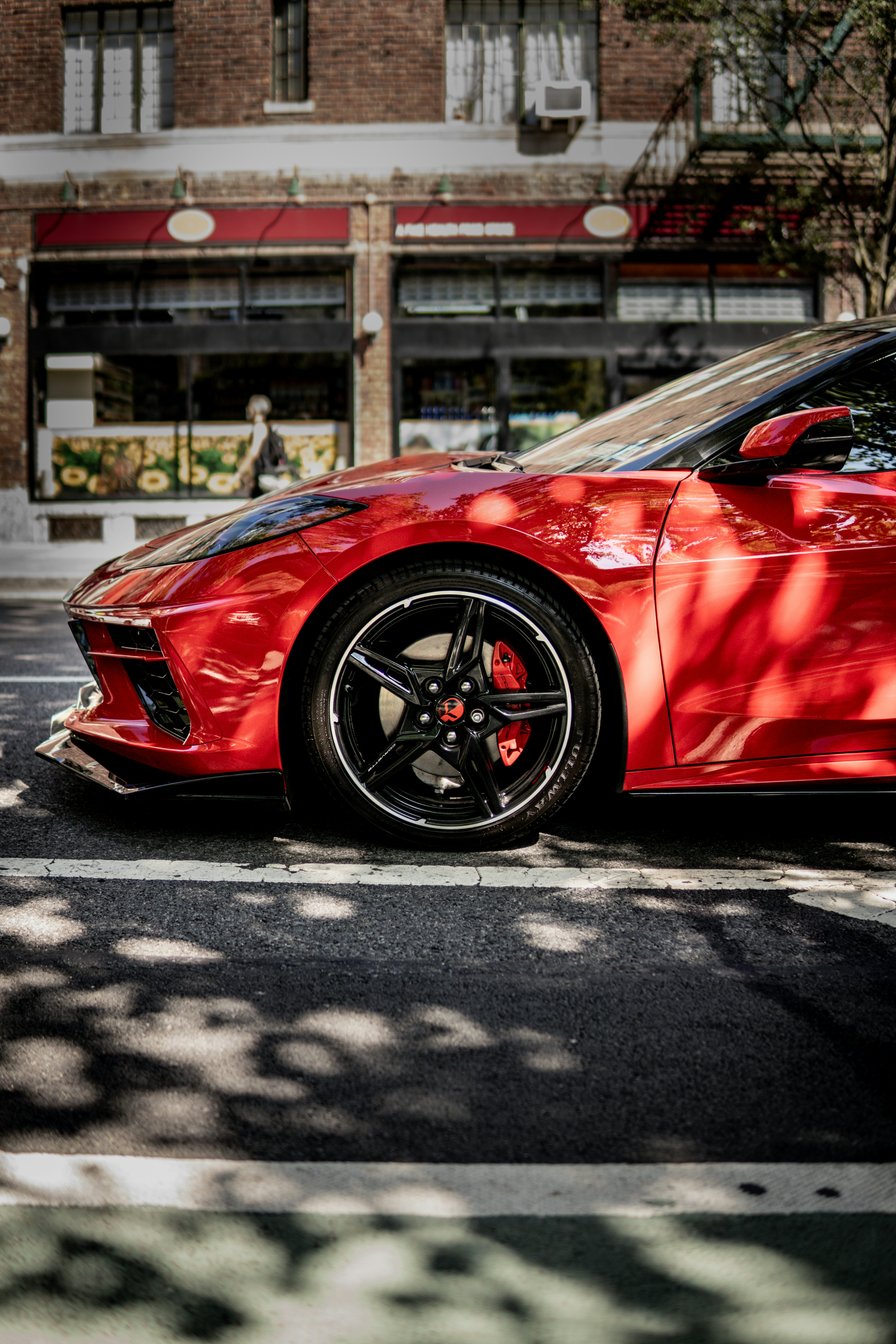 A red sports car parked on the side of the road
