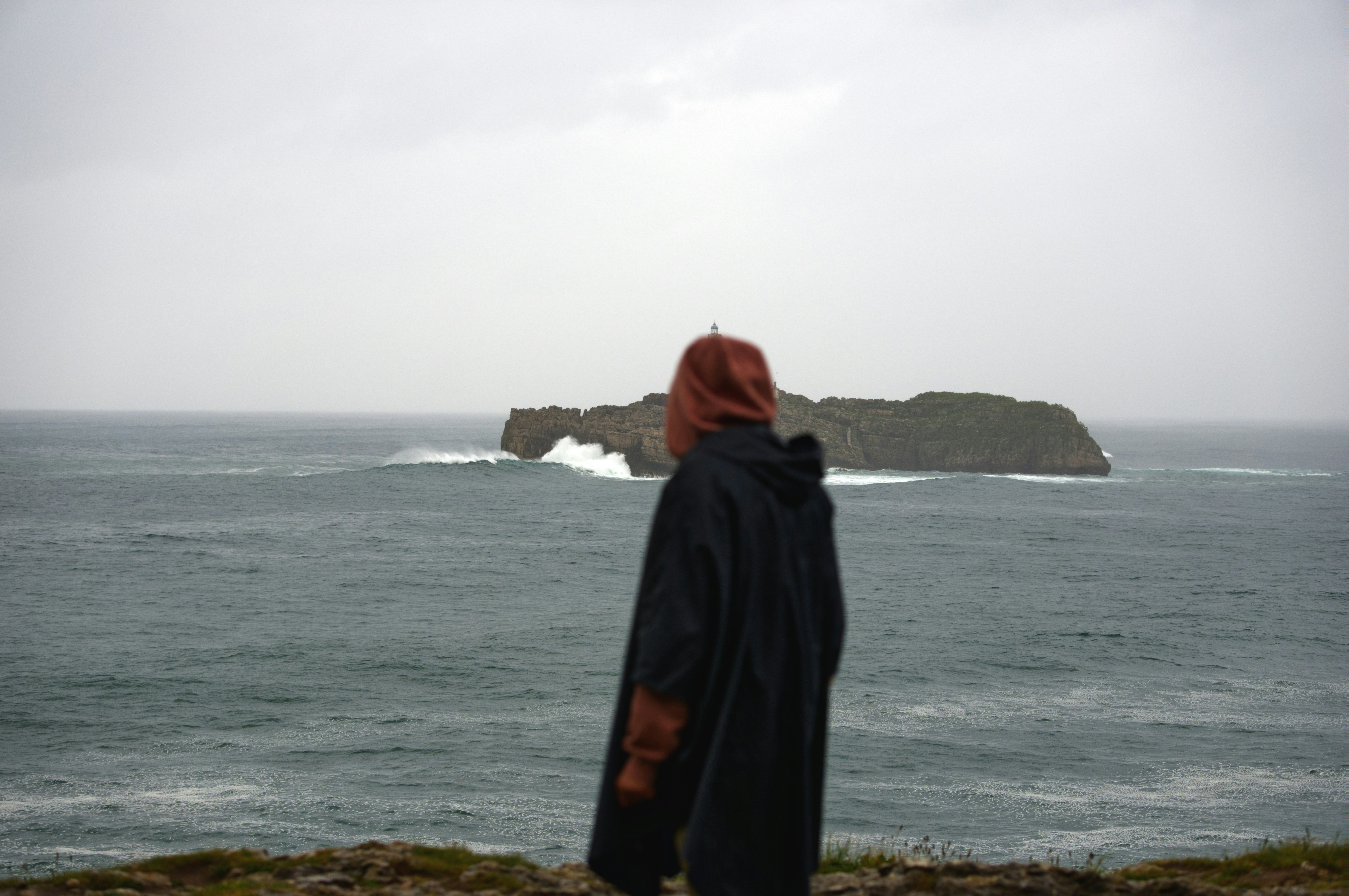 Horizon Gaze: A solitary figure by the sea