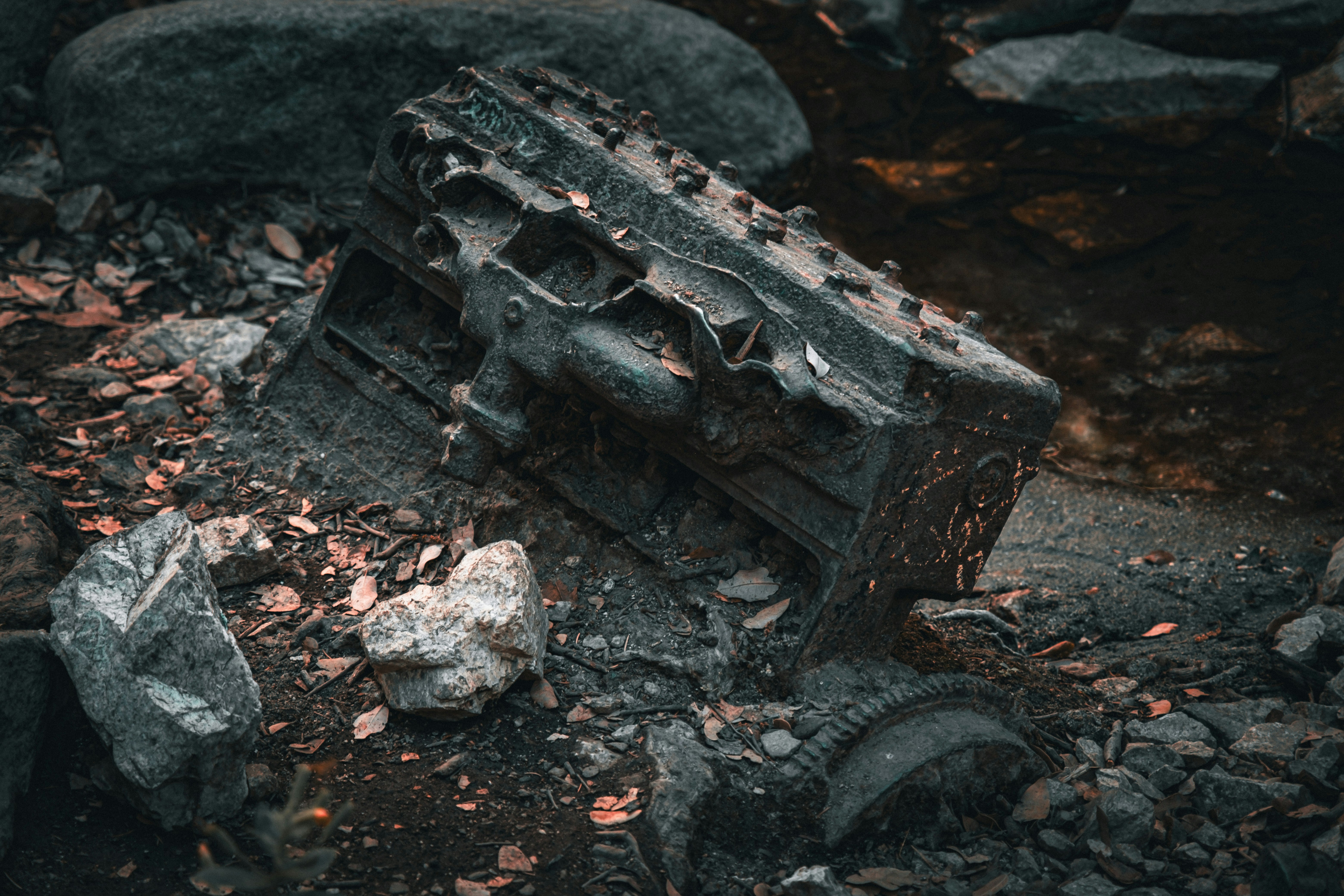 Rustbound Relic: A Weathered Tank Fragment Among Dark Rubble