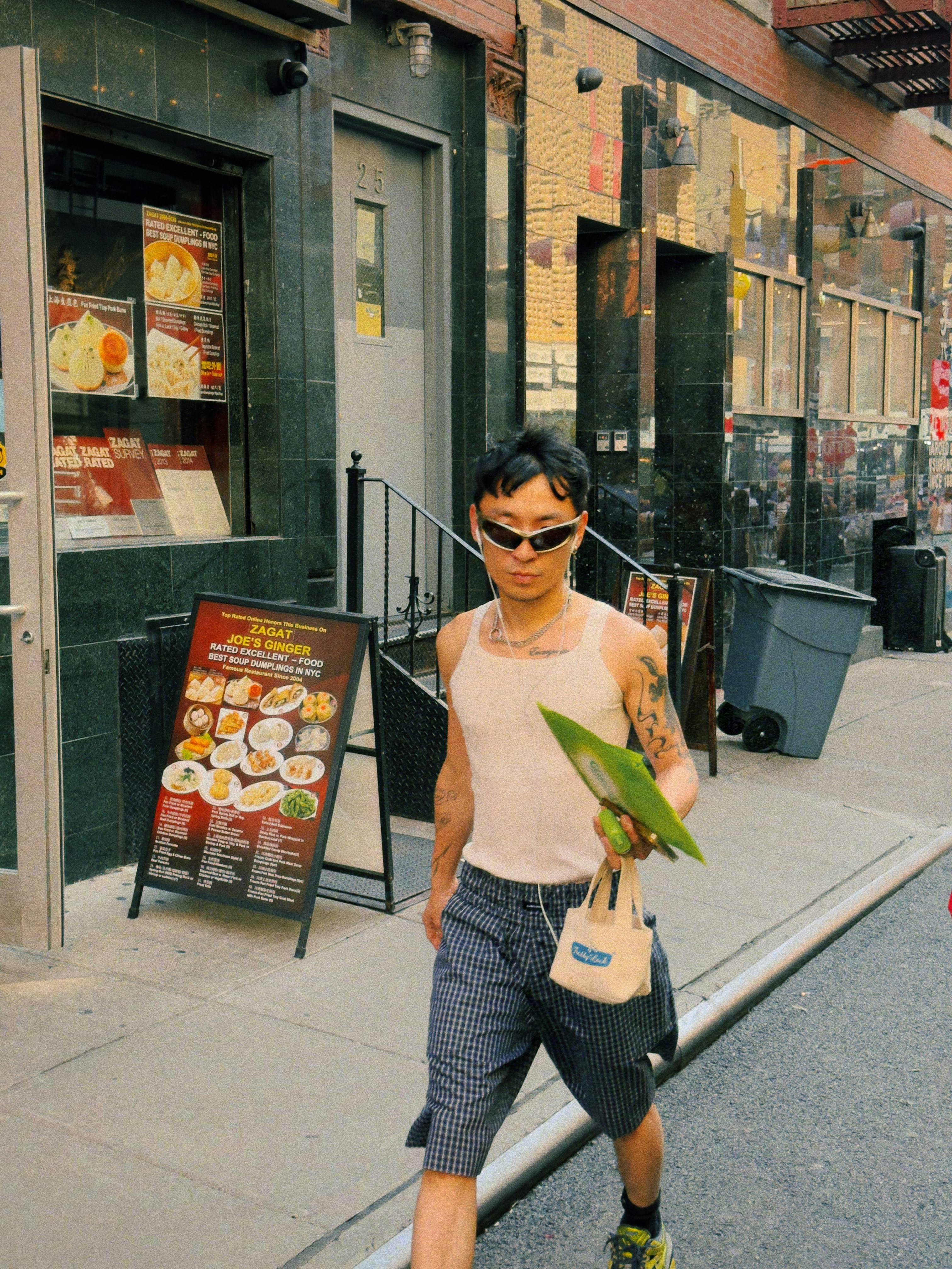 Street Runner in Sunglasses: A Sunlit Moment on a NYC Sidewalk