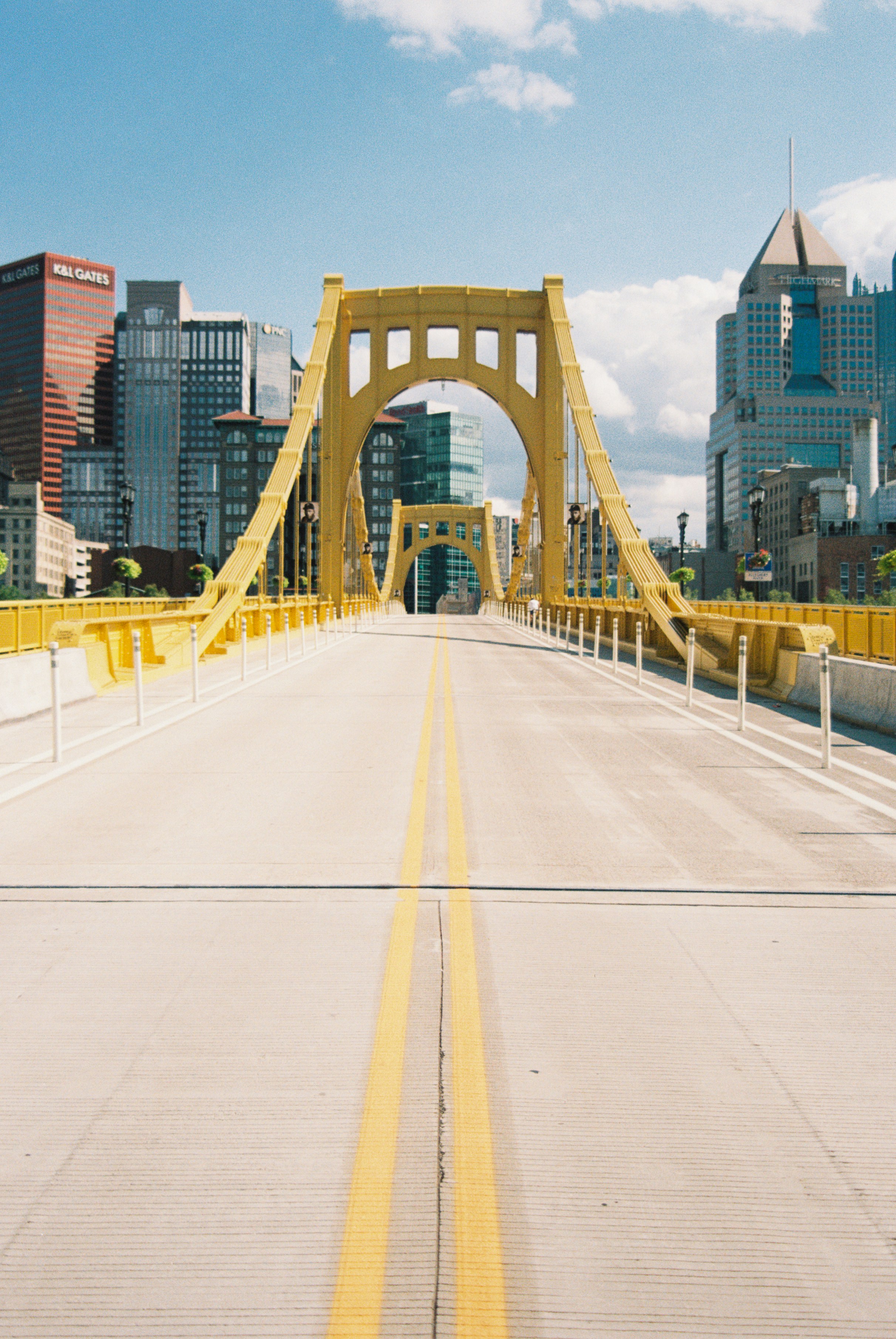 A yellow bridge with a city in the background photo – Free Pittsburgh ...