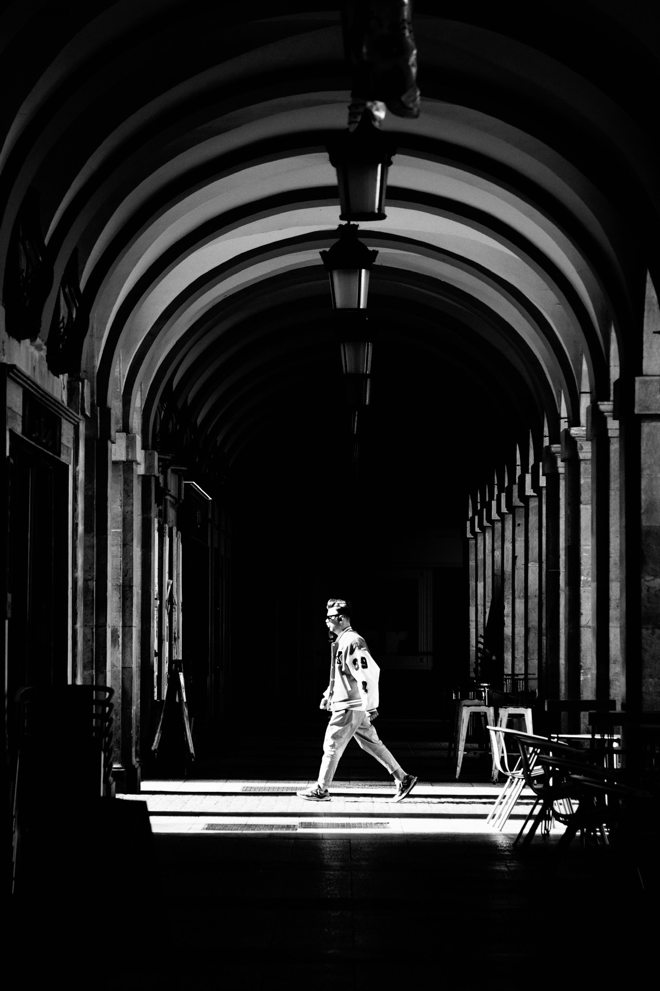 A person walking down a hall with a light on photo – Free Paí­s vasco ...