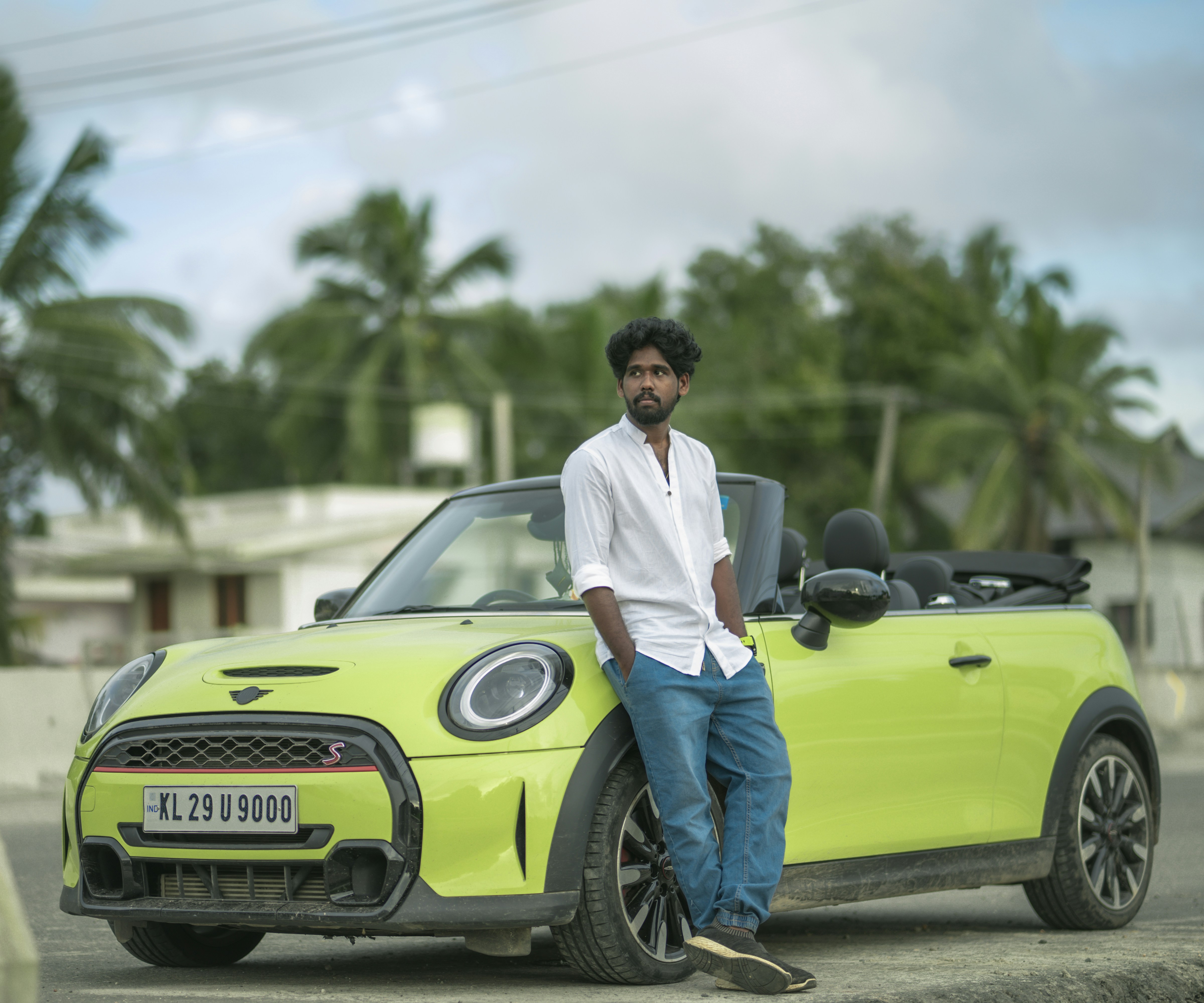 A man standing next to a green mini cooper photo – Free Kerala Image on ...