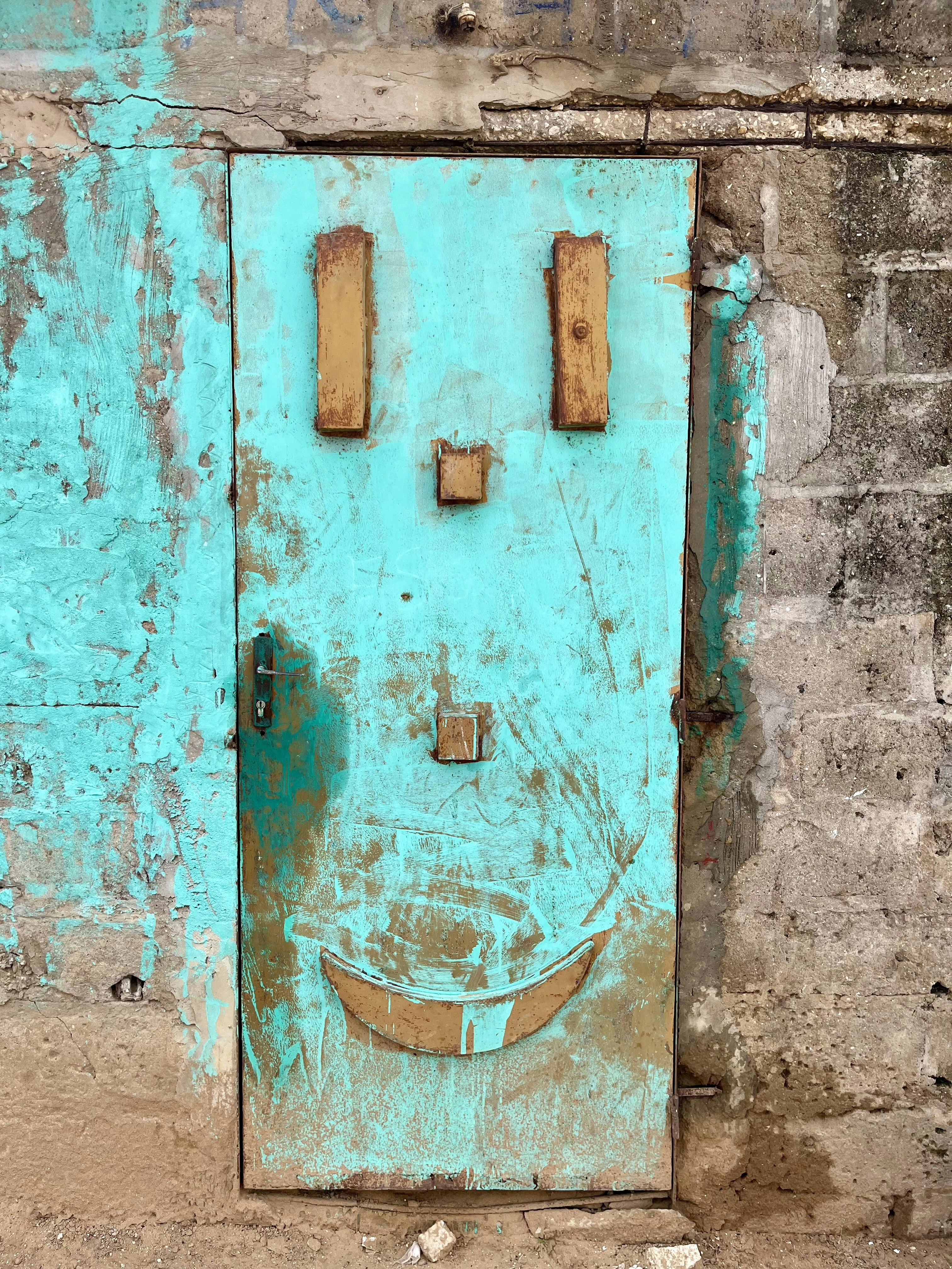 A blue door with a smiley face painted on it photo – Free Africa Image ...