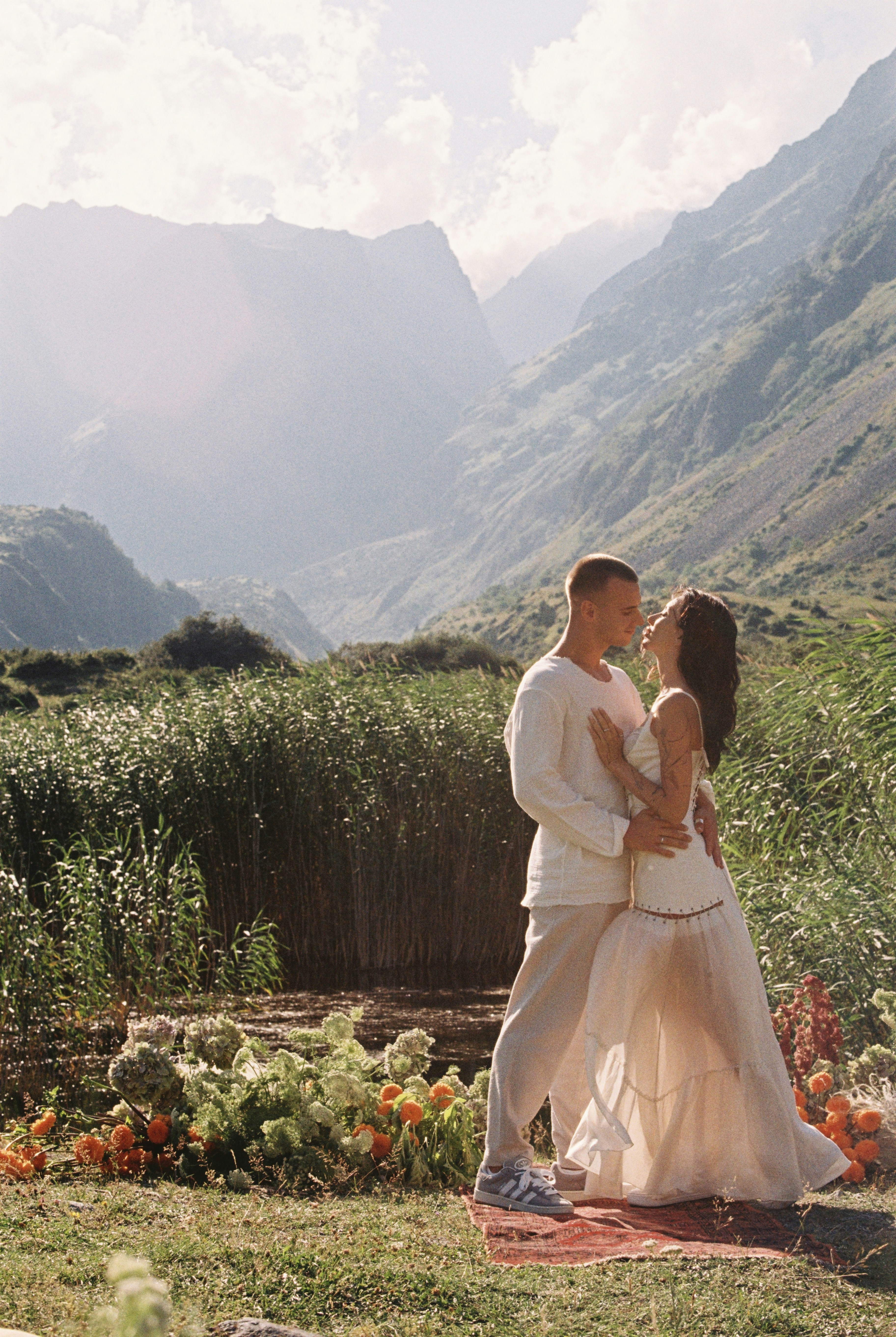 A man and a woman are standing in a field