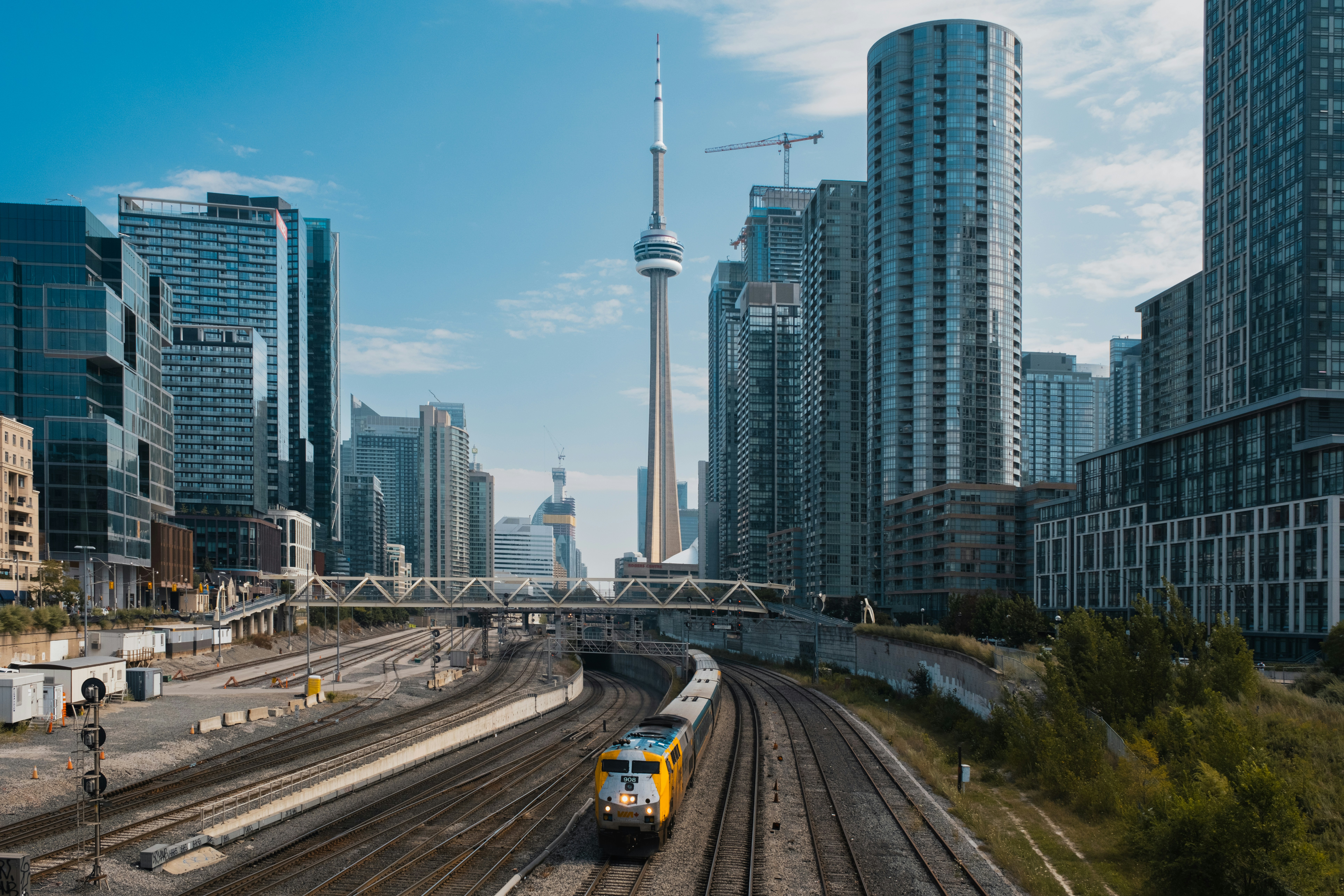 A train traveling through a city with tall buildings photo – Free ...
