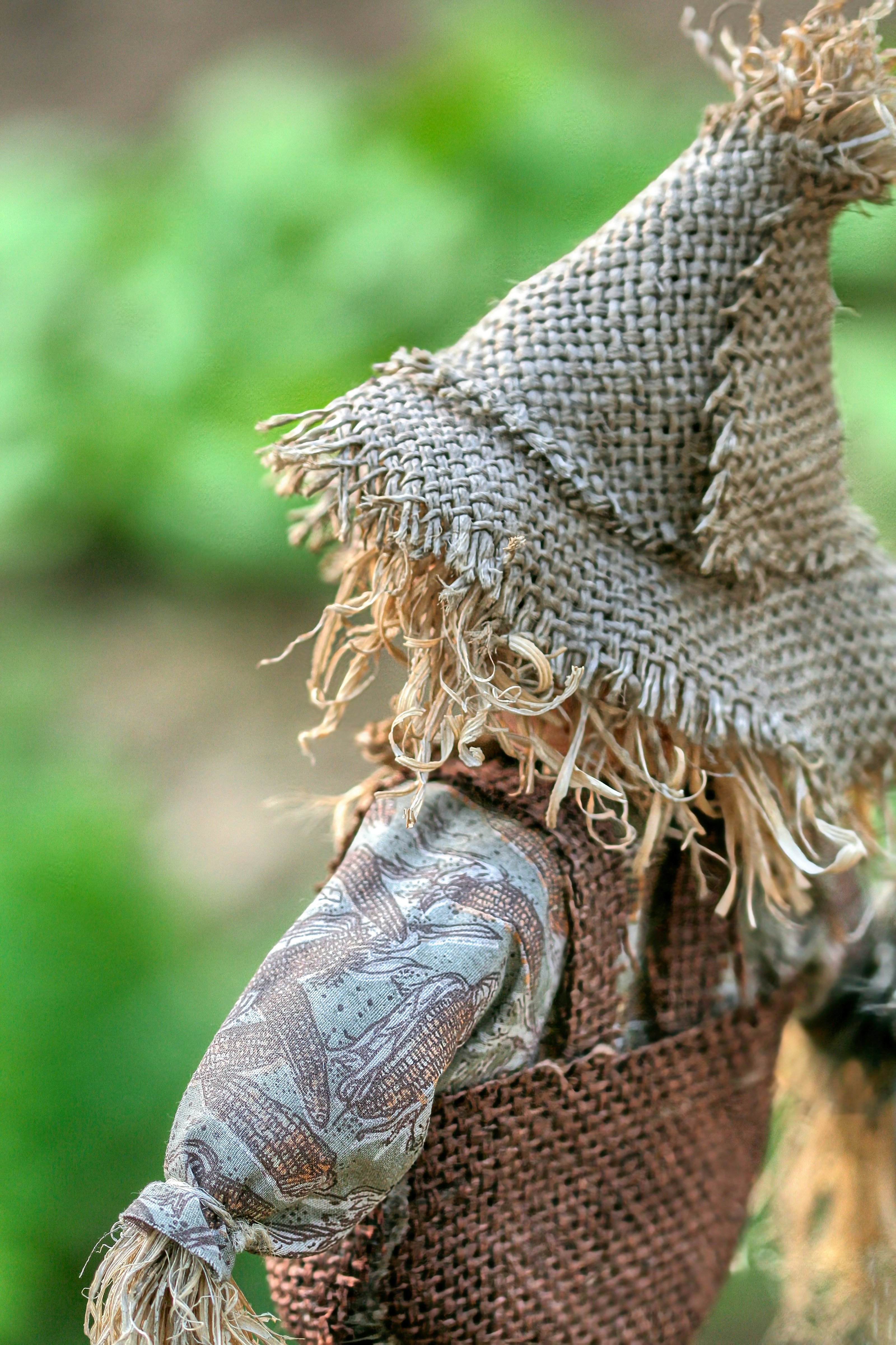 A scarecrow with a hat and a bag