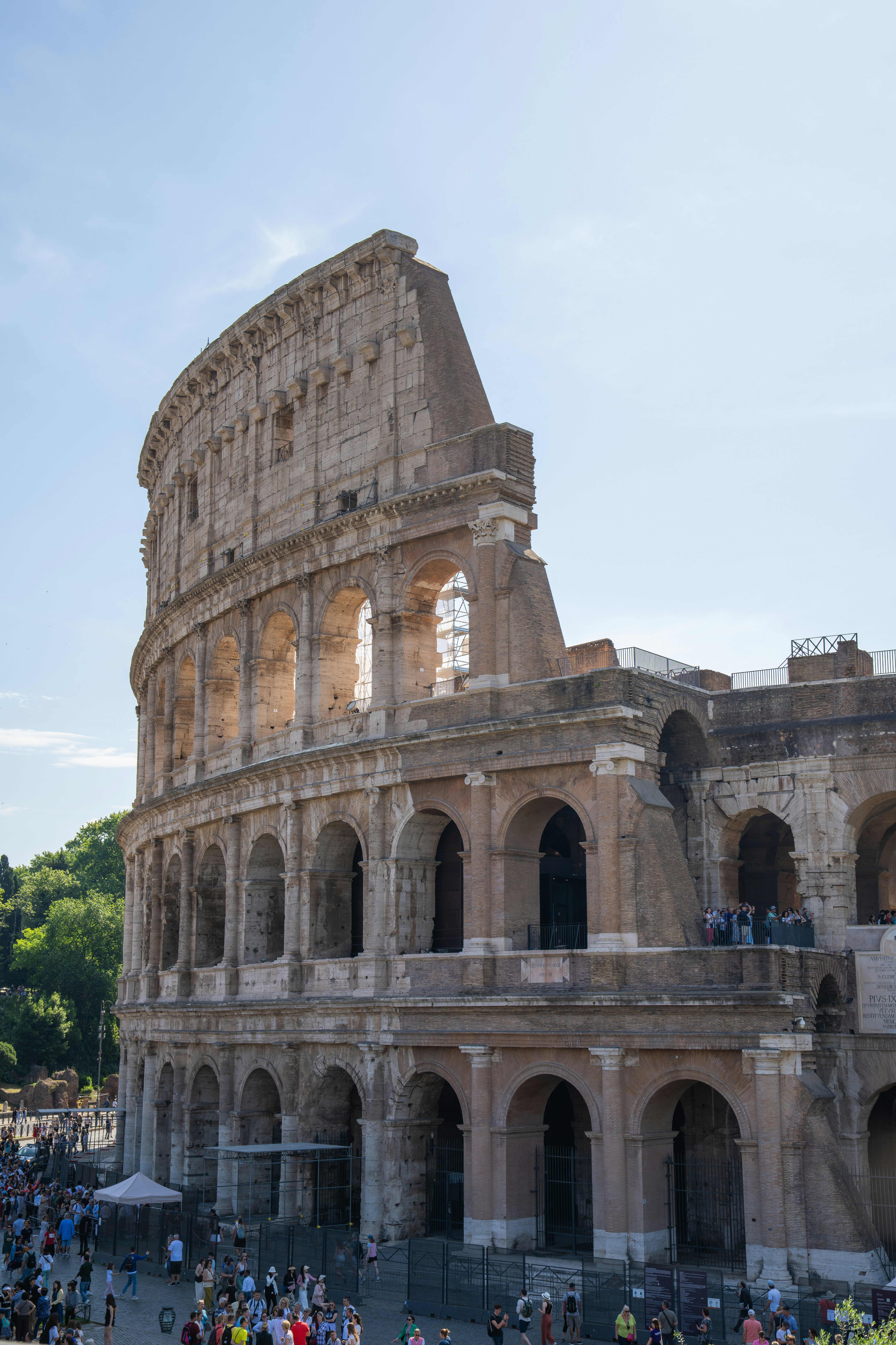 A crowd of people standing around an old building photo – Free The ...