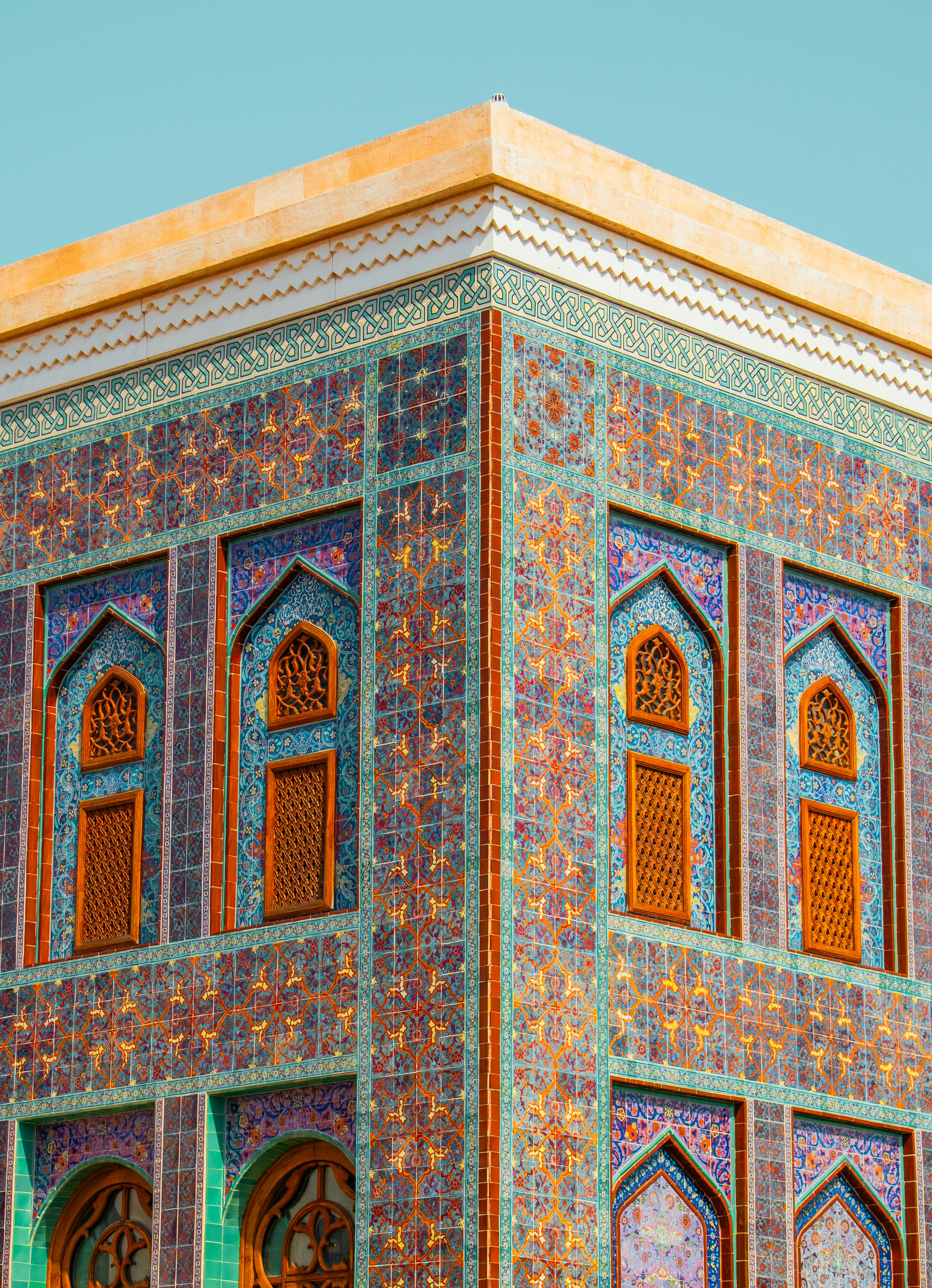 Tilework Corner: A diagonal slice of ornamental facade in vivid turquoise and orange