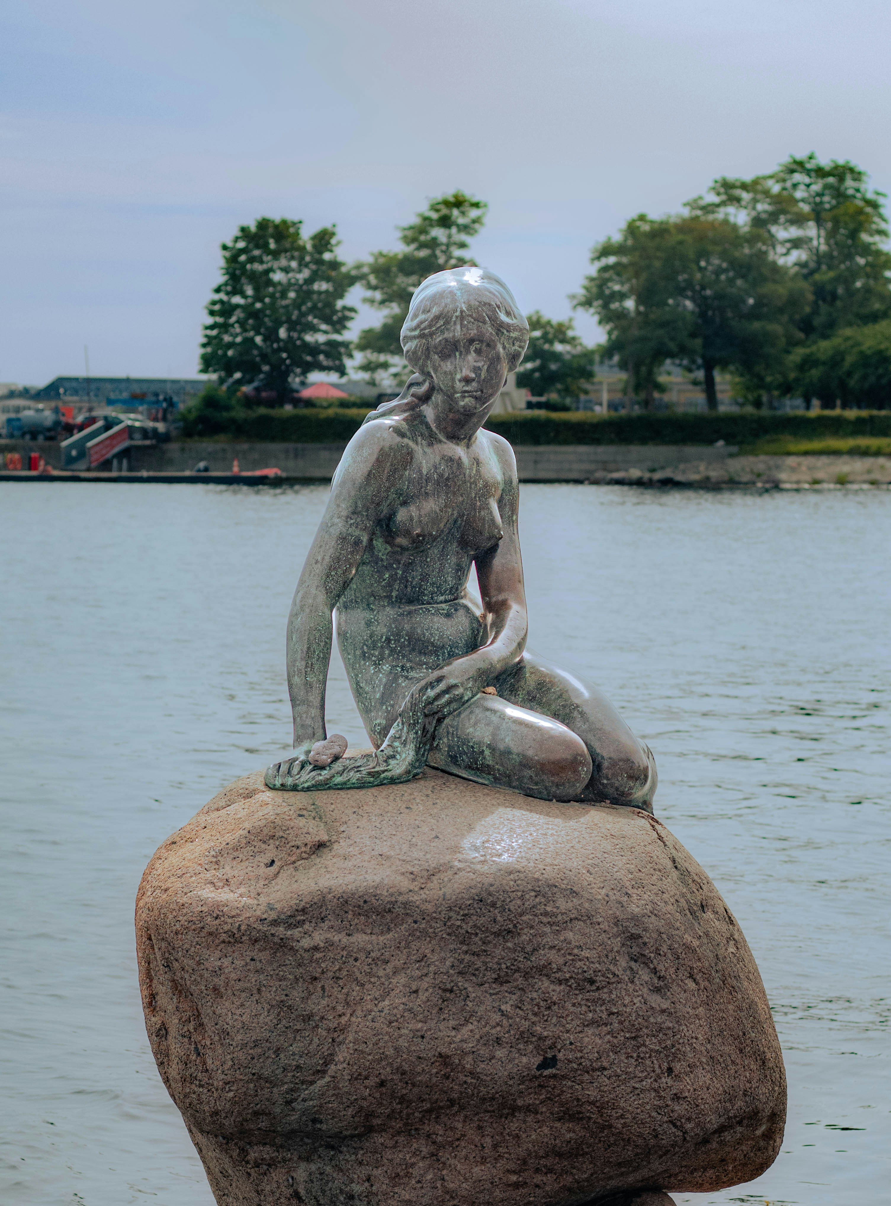 A statue of a mermaid sitting on top of a rock photo – Free Copenhagen ...