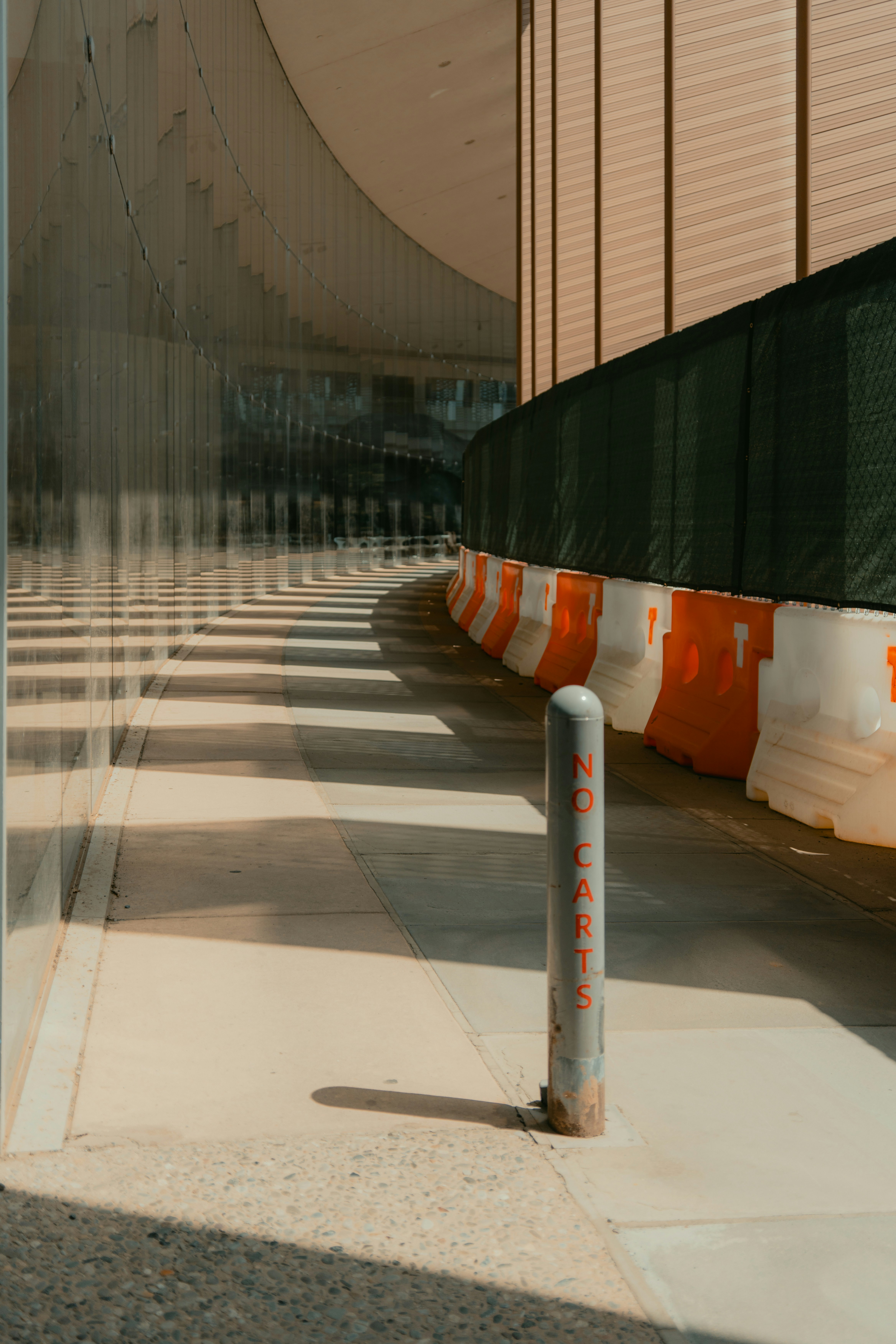 No Cars Post Framing a Curved Glass Corridor