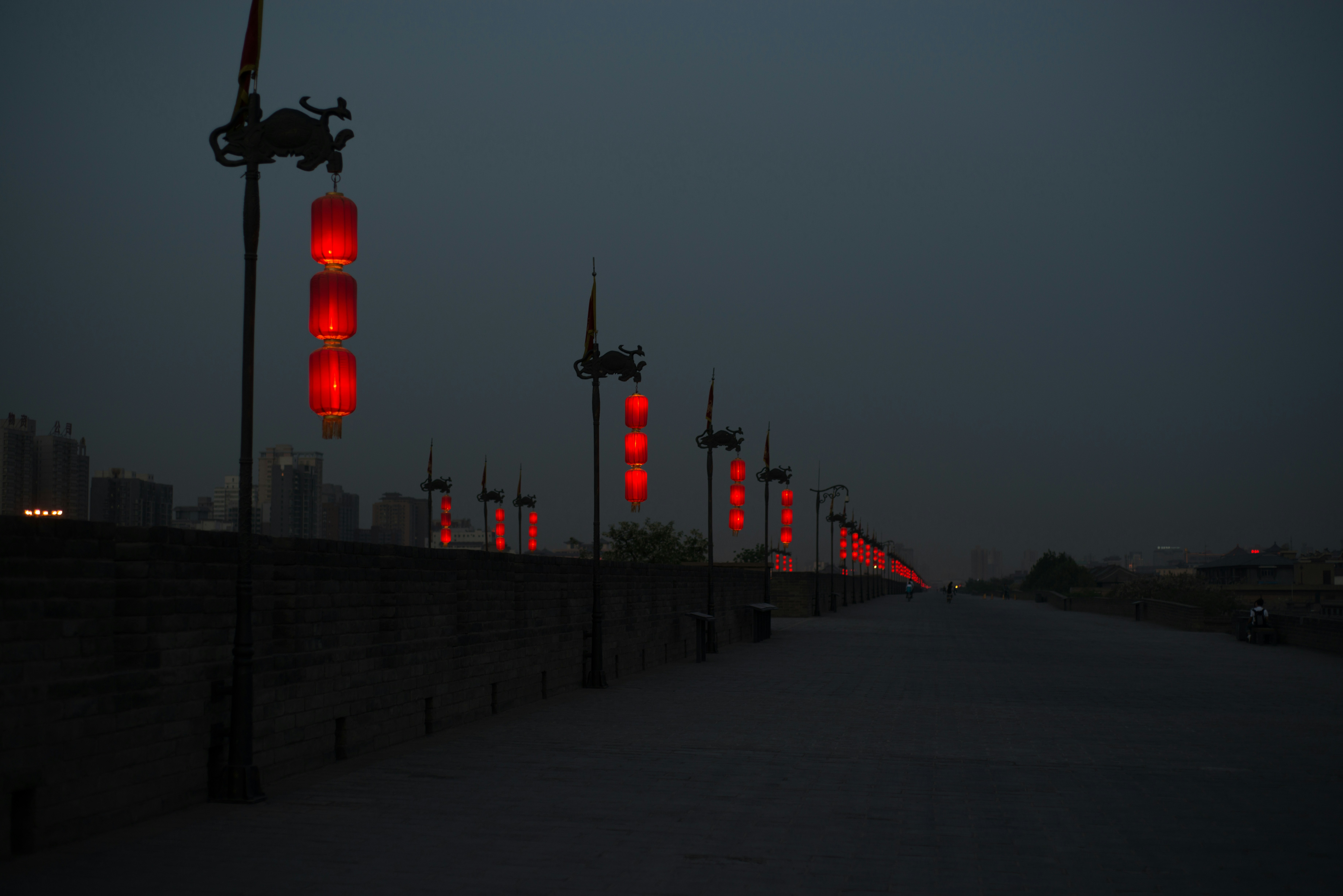 Red Lanterns Lead the Quiet Promenade Toward the Distant City
