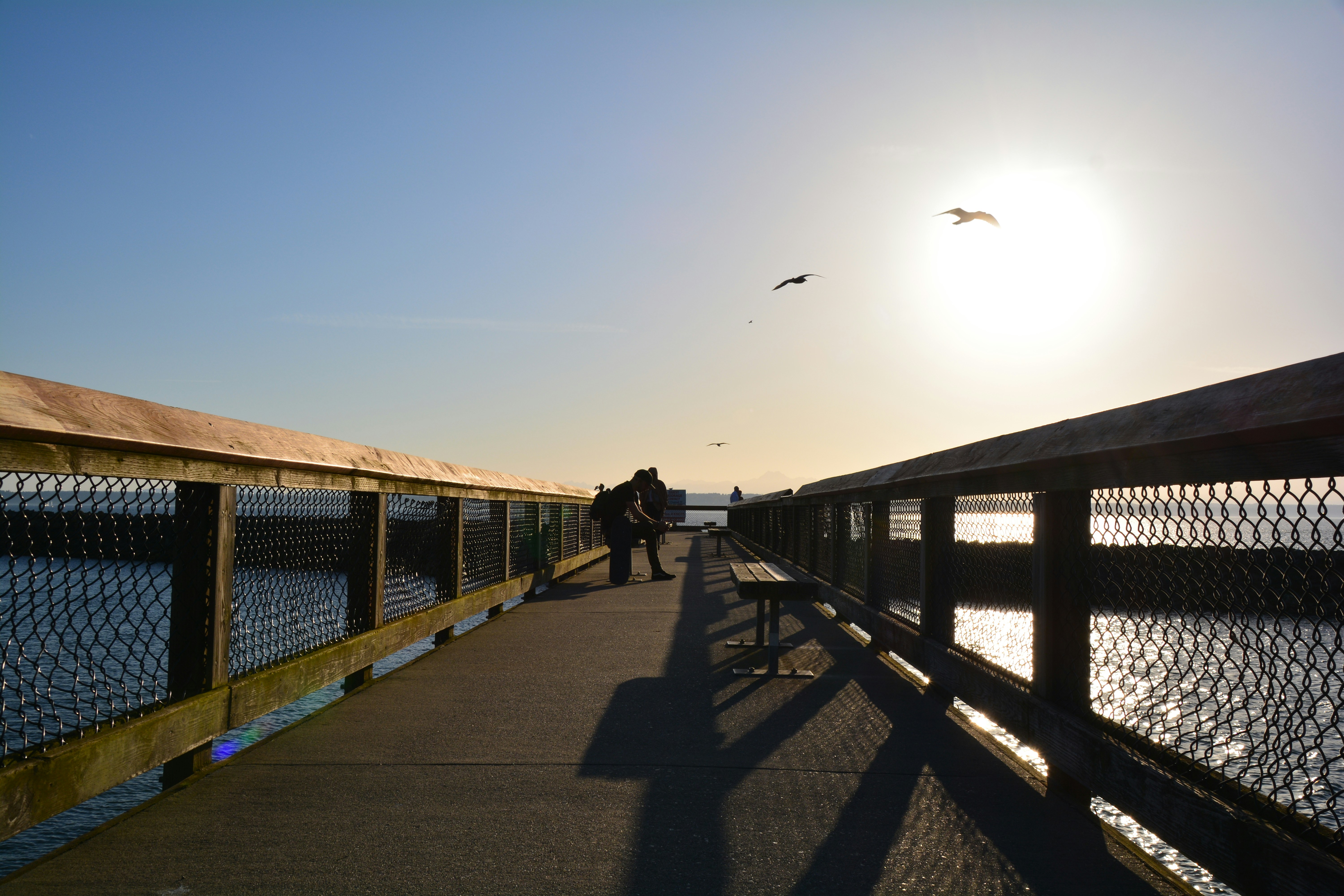 Dusk on the Promenade: Two Figures Framed by a Glowing Horizon