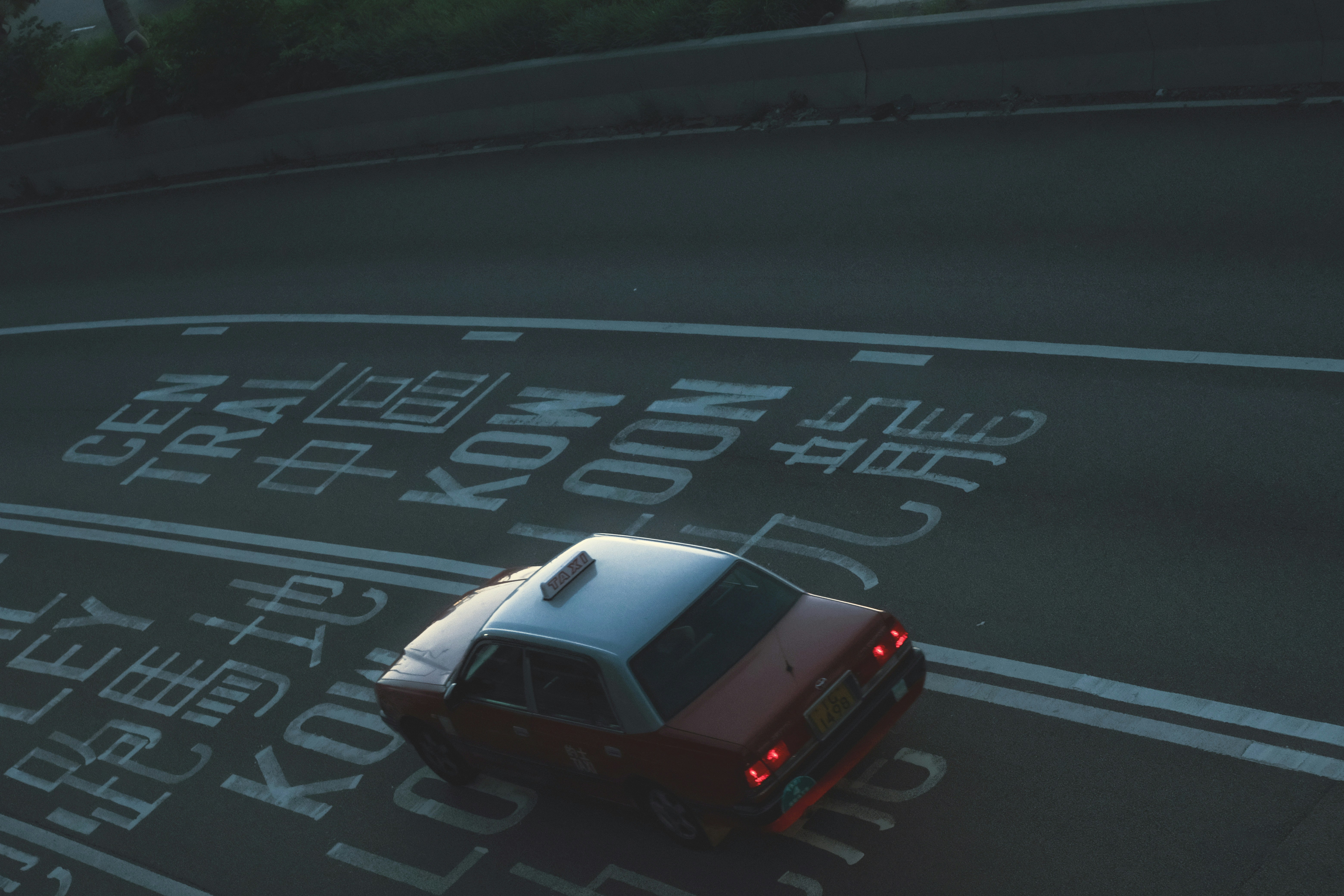 A car driving down a street next to a traffic light