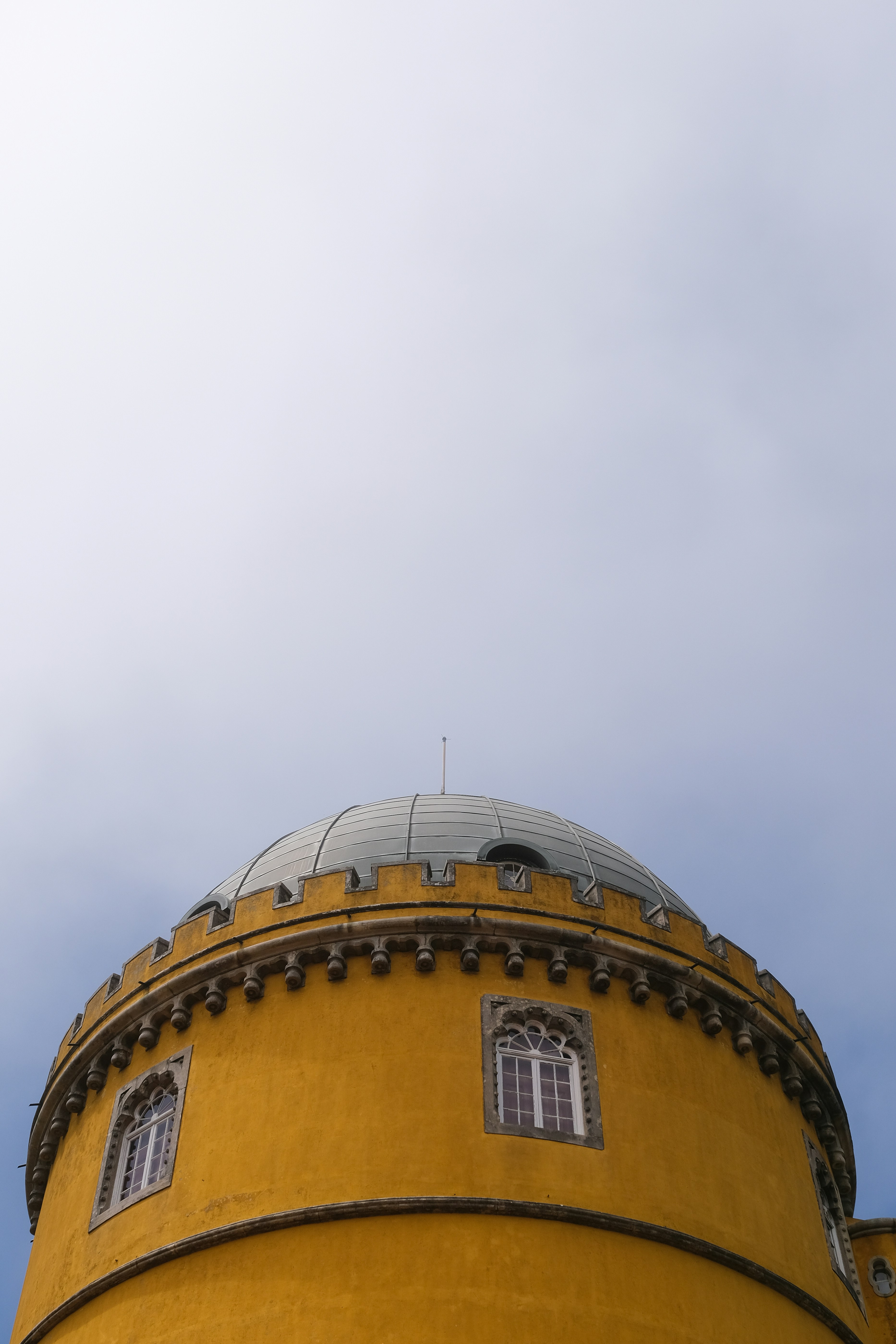 A tall yellow building with a clock on it's side photo – Free Sintra ...