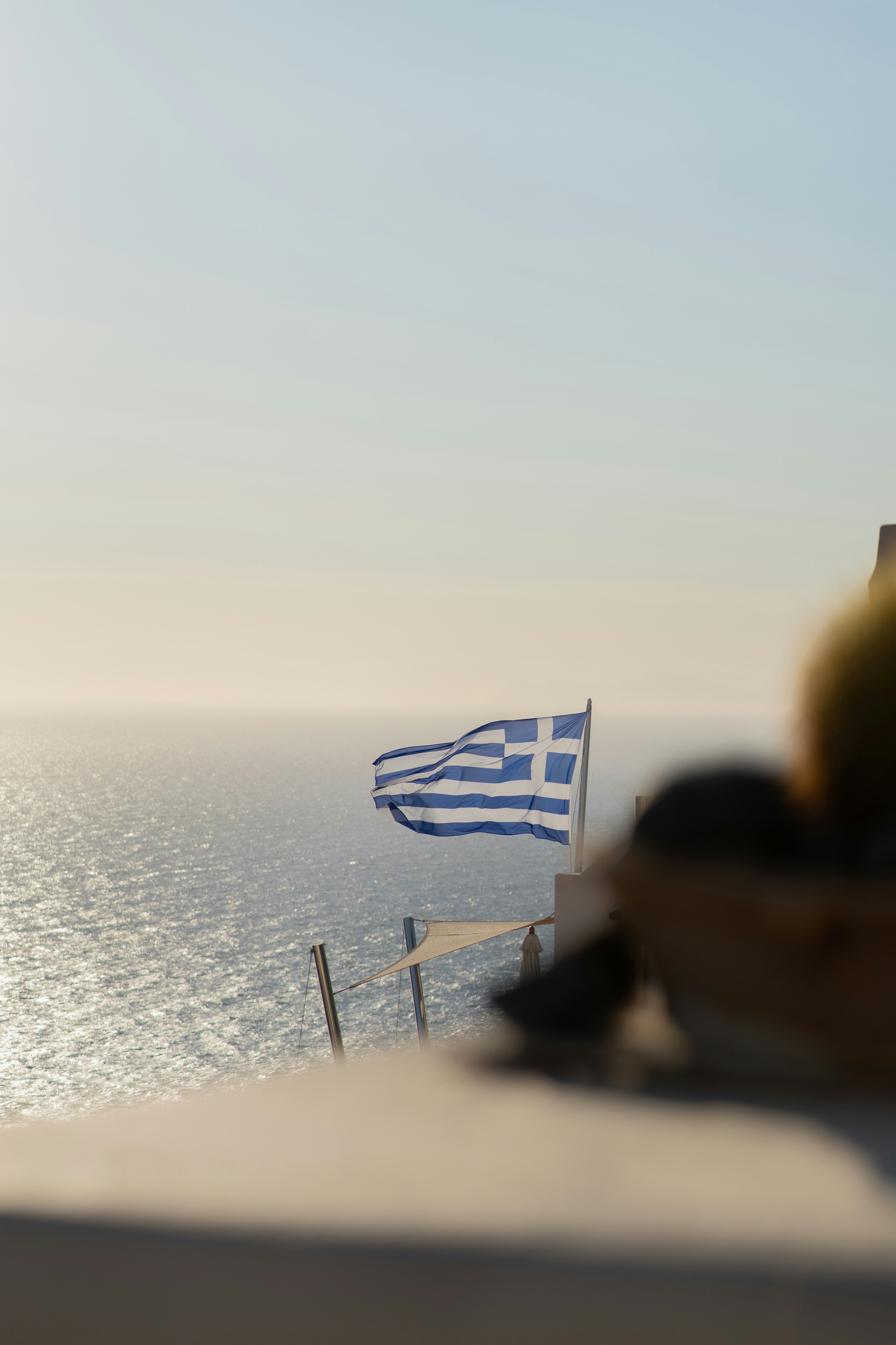 Aegean Flag in the Dusk Light Over a Quiet Seascape
