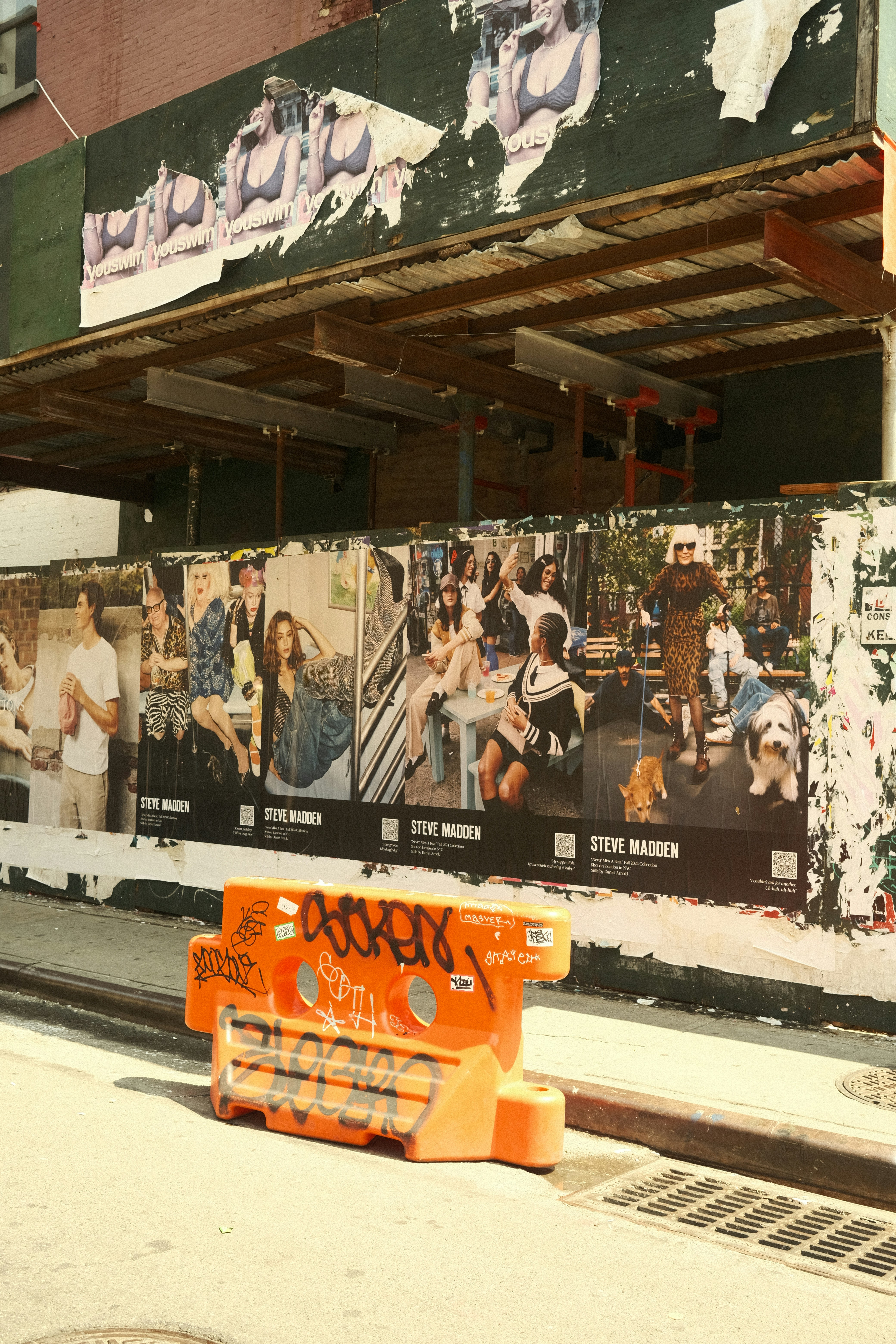 A building with a bunch of posters on it photo – Free Street ...