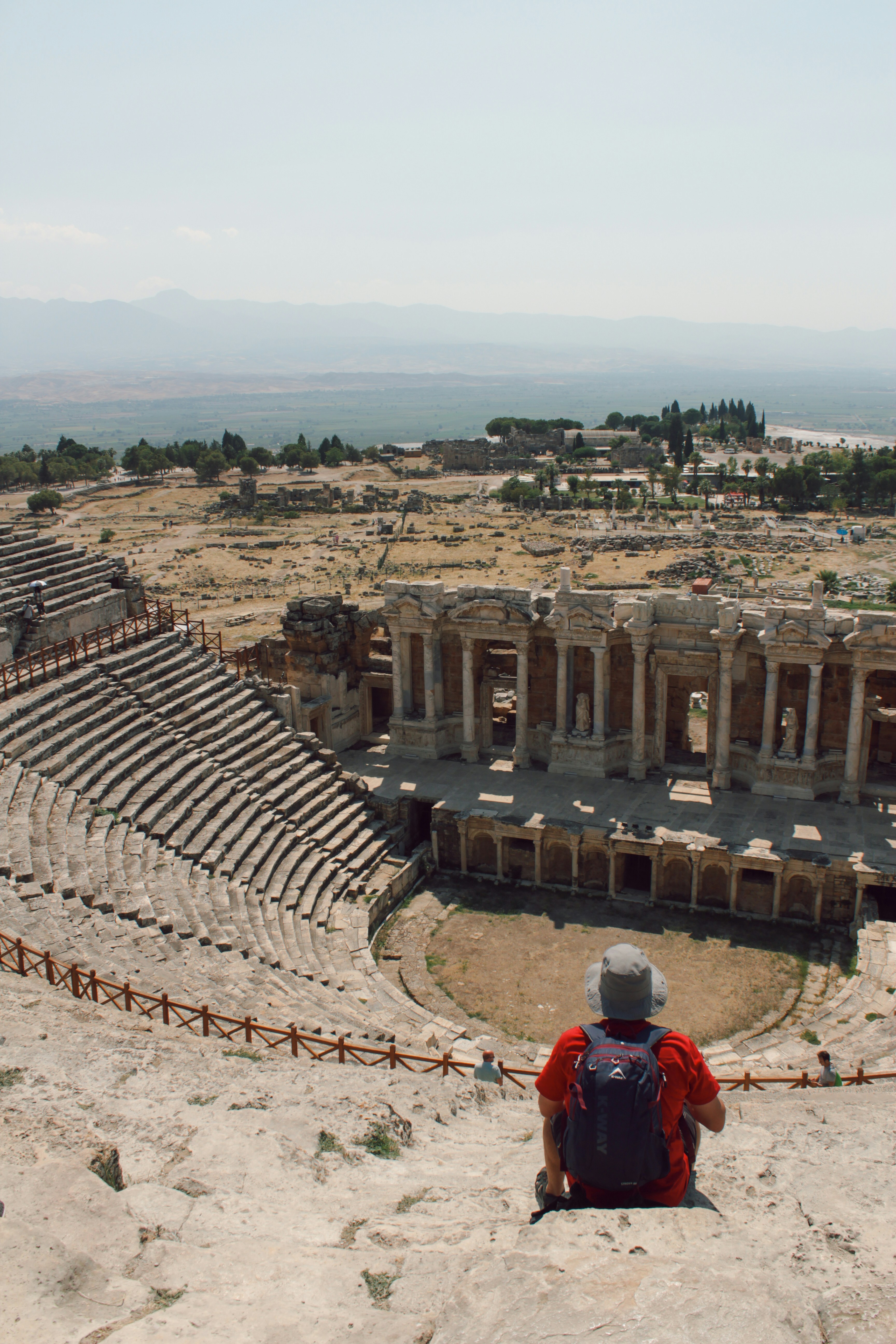 Whispers of Stone: a Traveler Gazes Across an Ancient Amphitheater