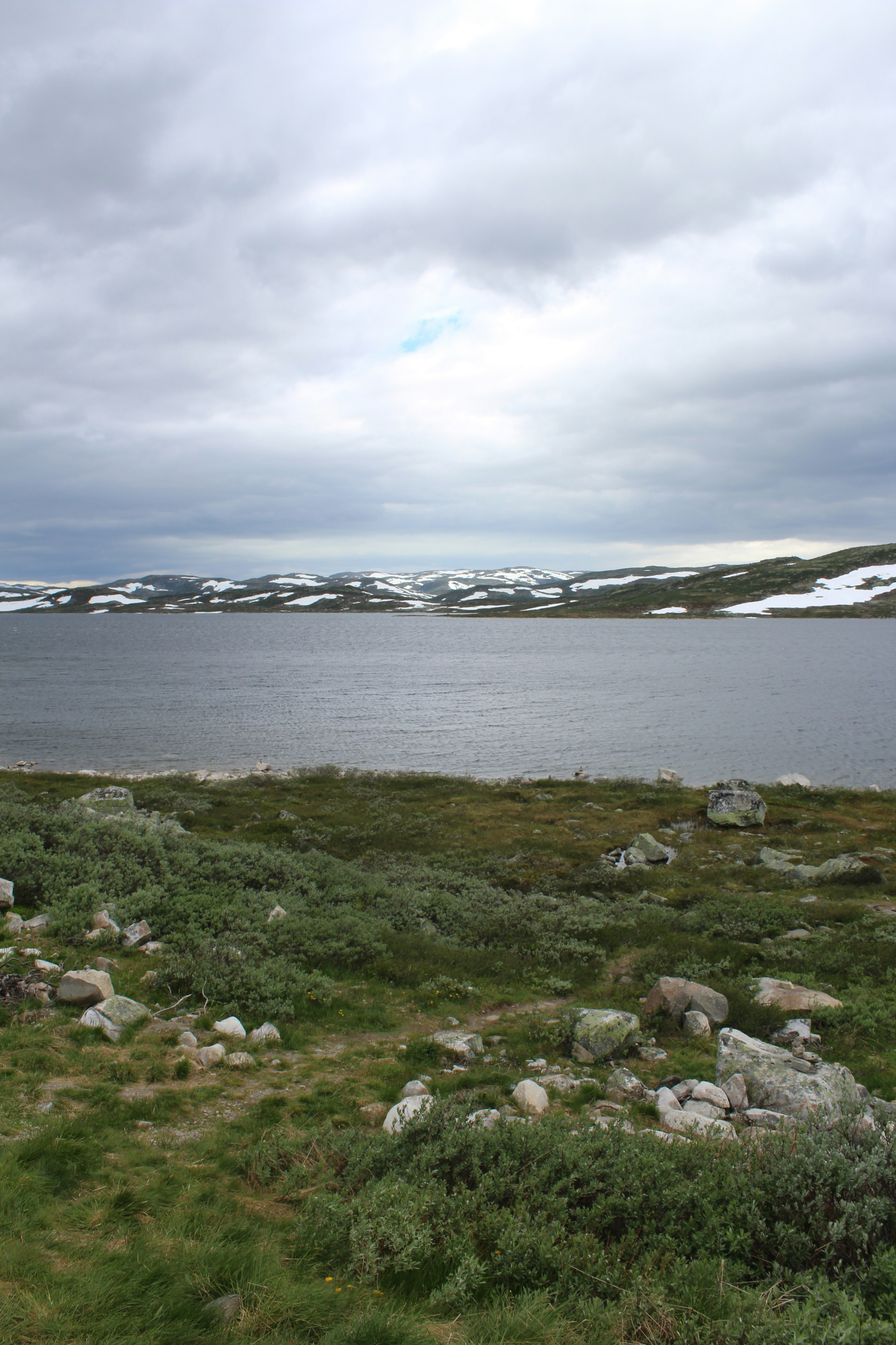 Horizon of Snow and Stone Along a Quiet Alpine Lake