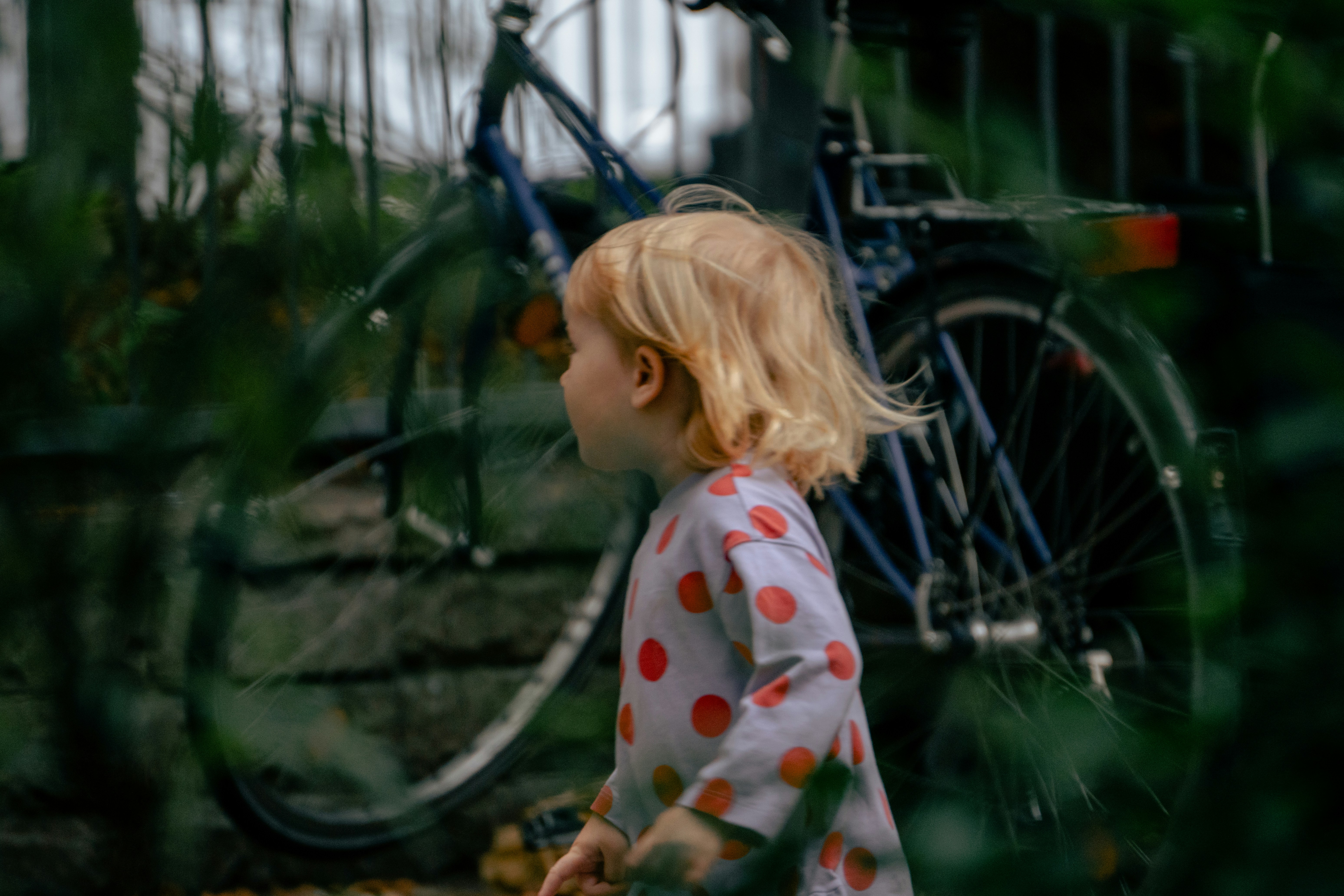 Child in Motion: A Soft-focus Moment by the Bicycle Garden