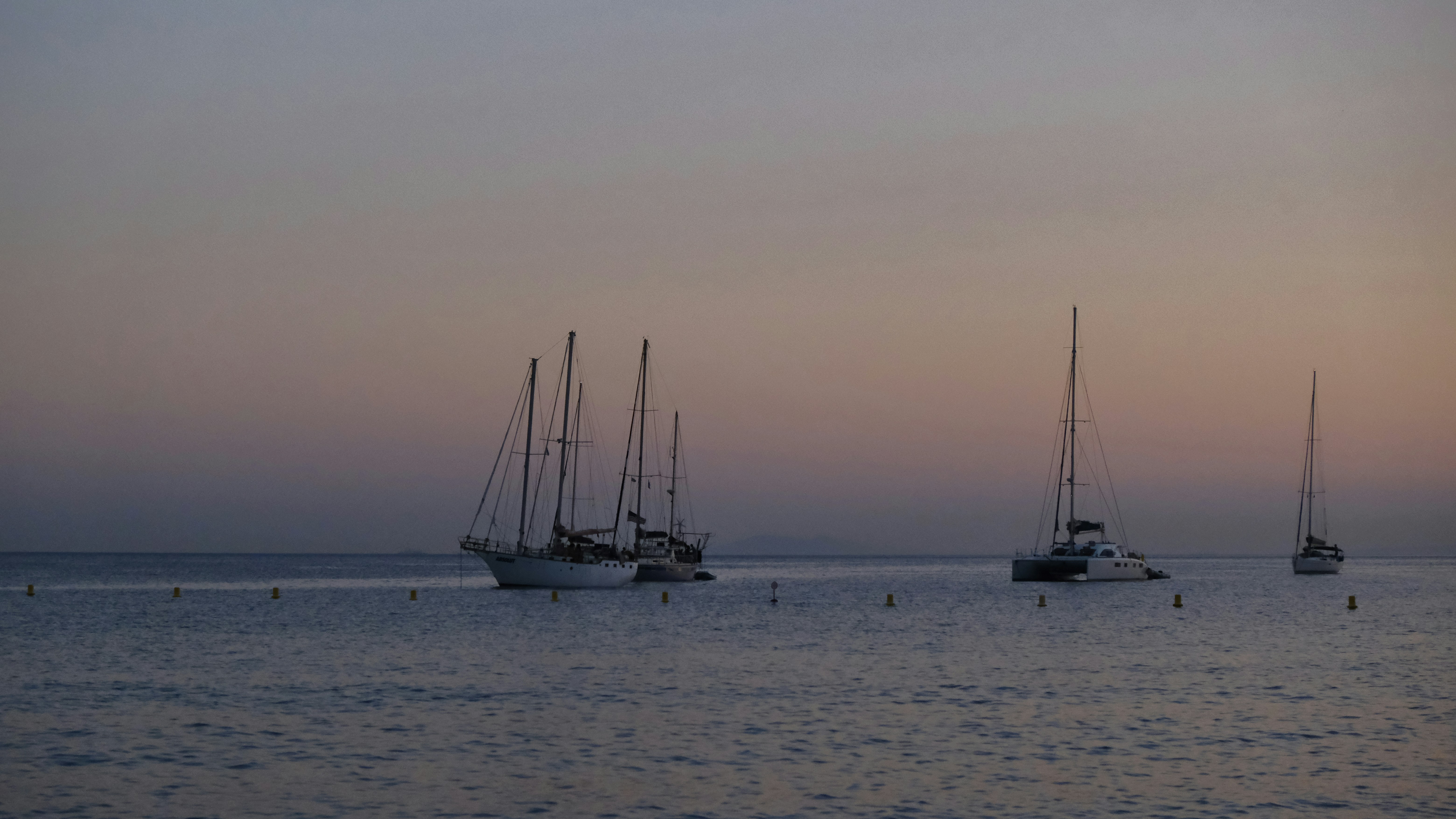 A group of boats floating on top of a body of water photo – Free Sky ...