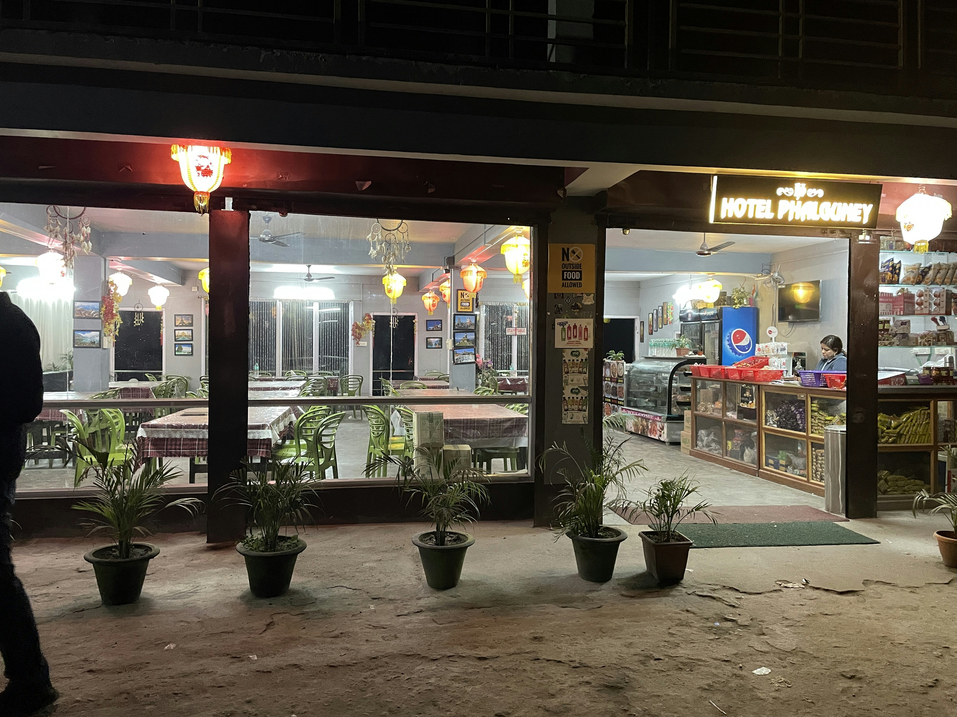 Neon-lit Café Facade Across a Quiet Night Market
