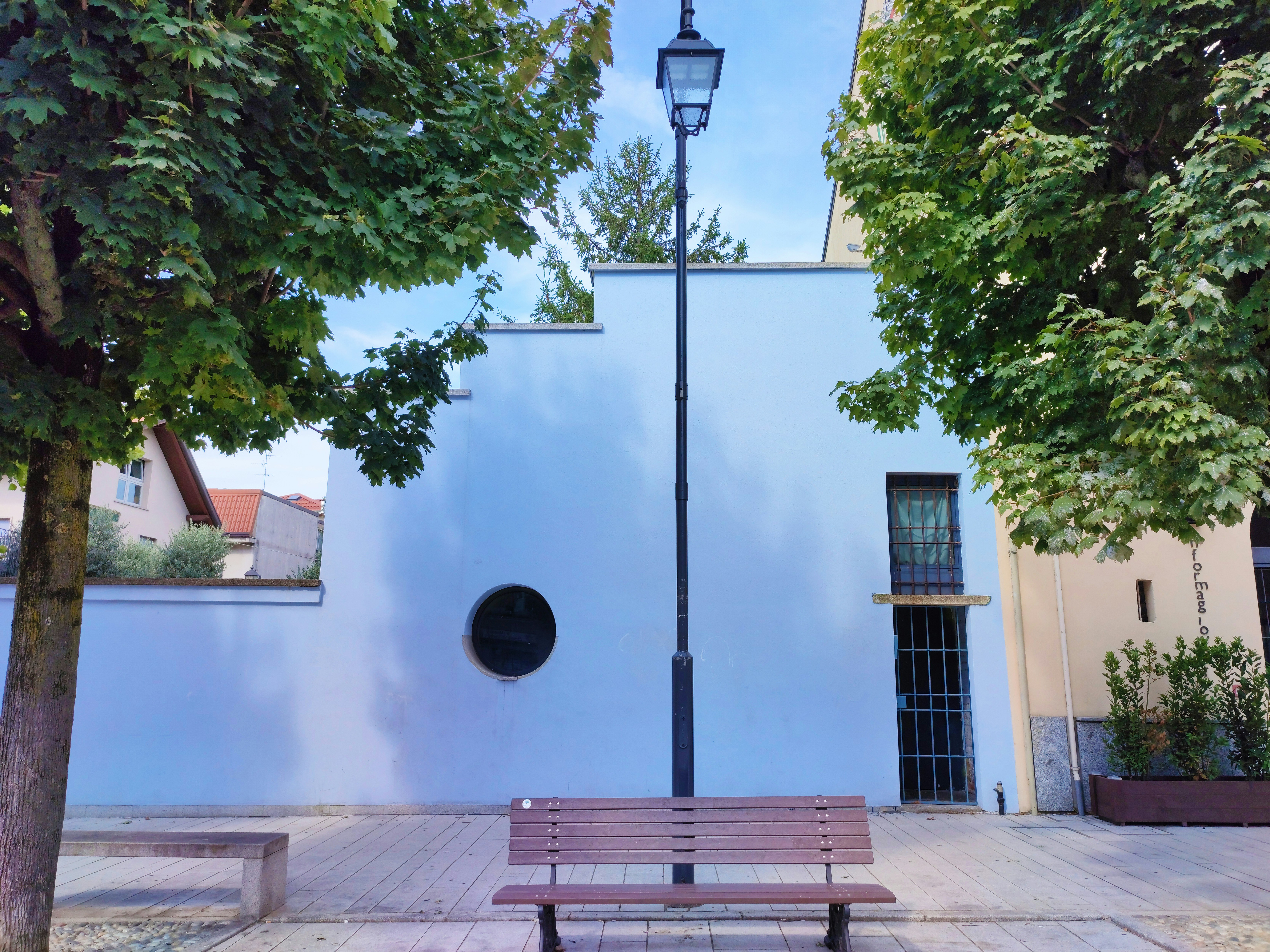 Central Lantern, Blue Wall, and Framing Trees: A Quiet Urban Portrait
