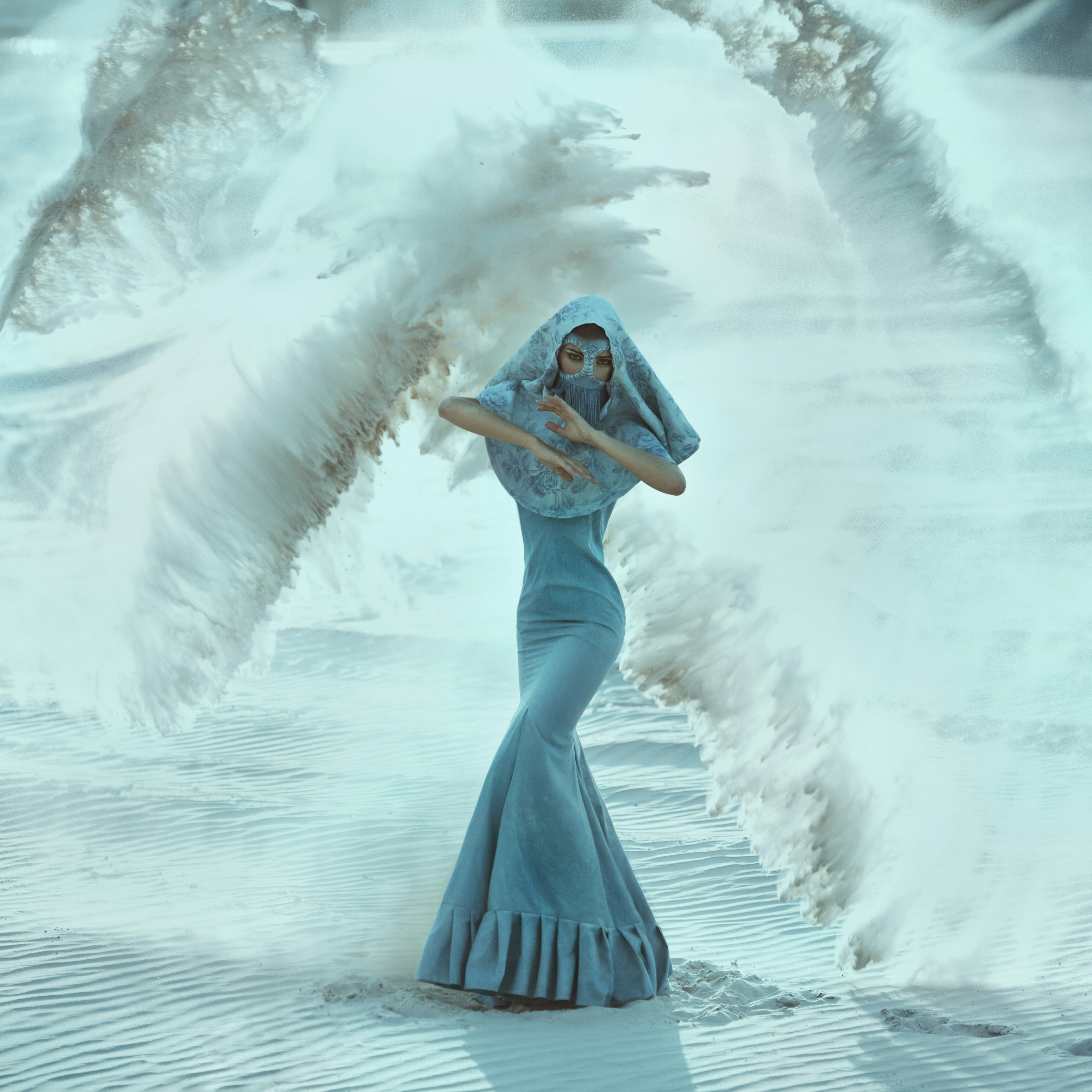 Ice-dancer in a blue veil conjures a frozen arc