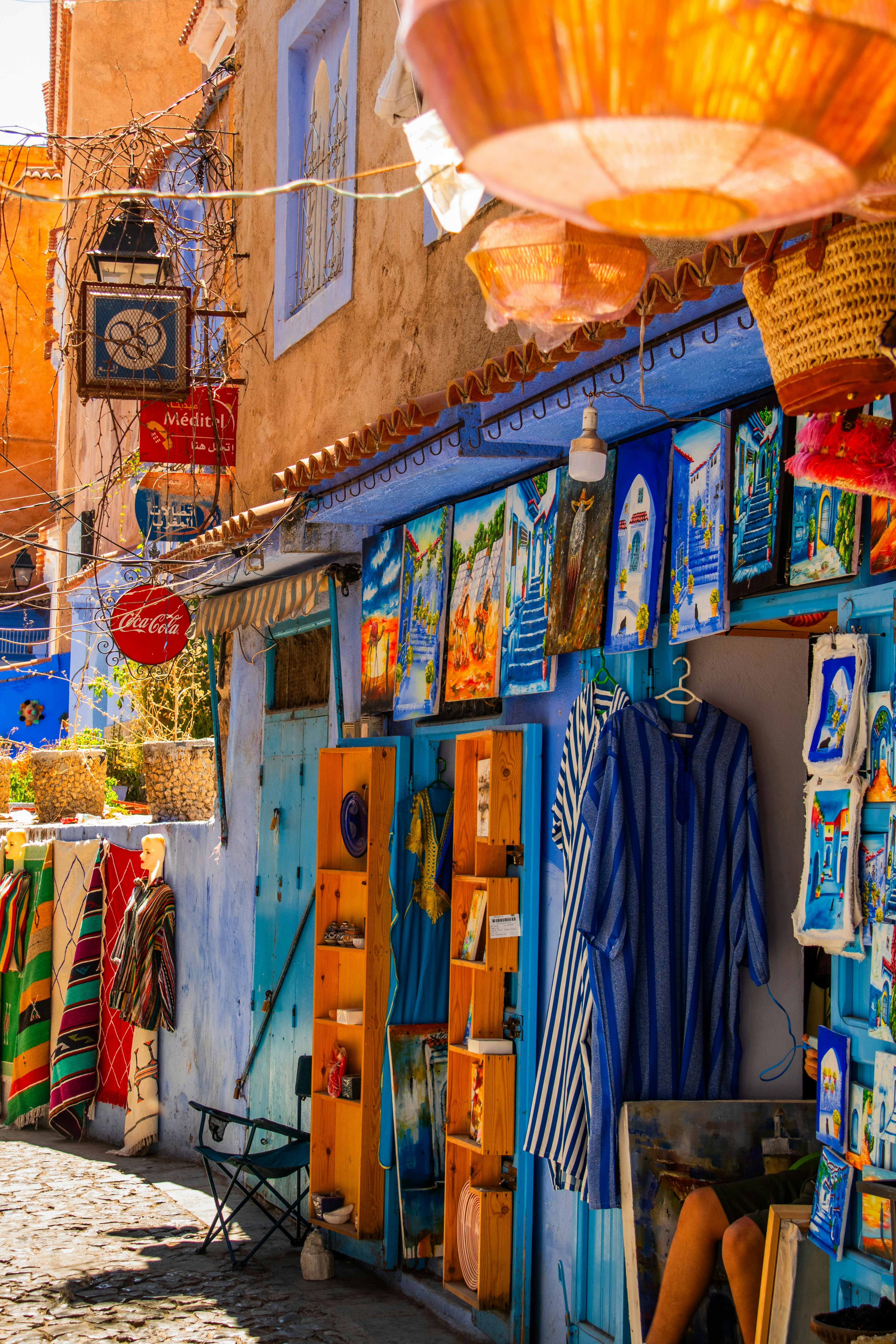 A narrow street with a lot of colorful items on display photo – Free ...