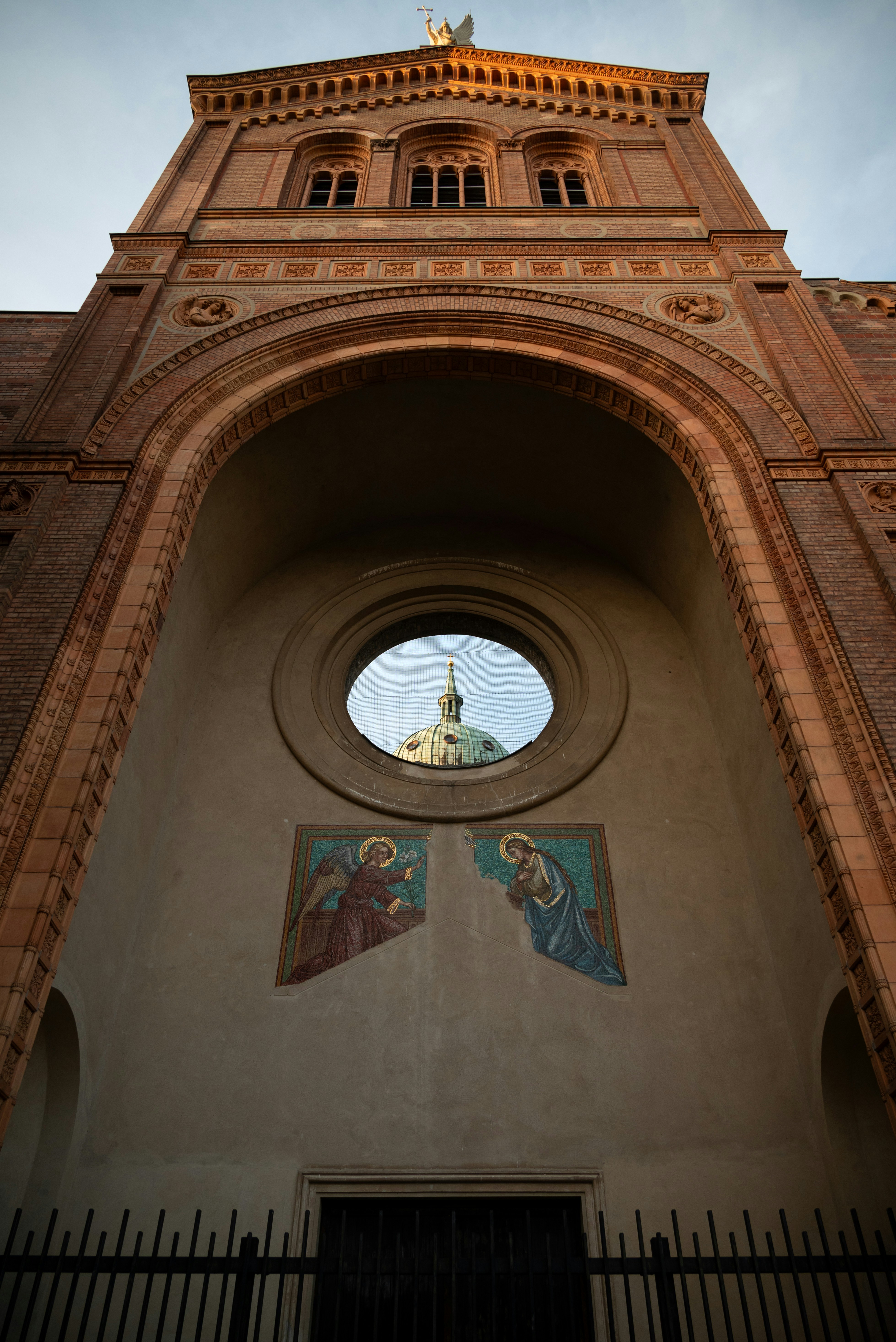 Archway Viewfinder: Circular Window Framing a Dome Above Painted Panels
