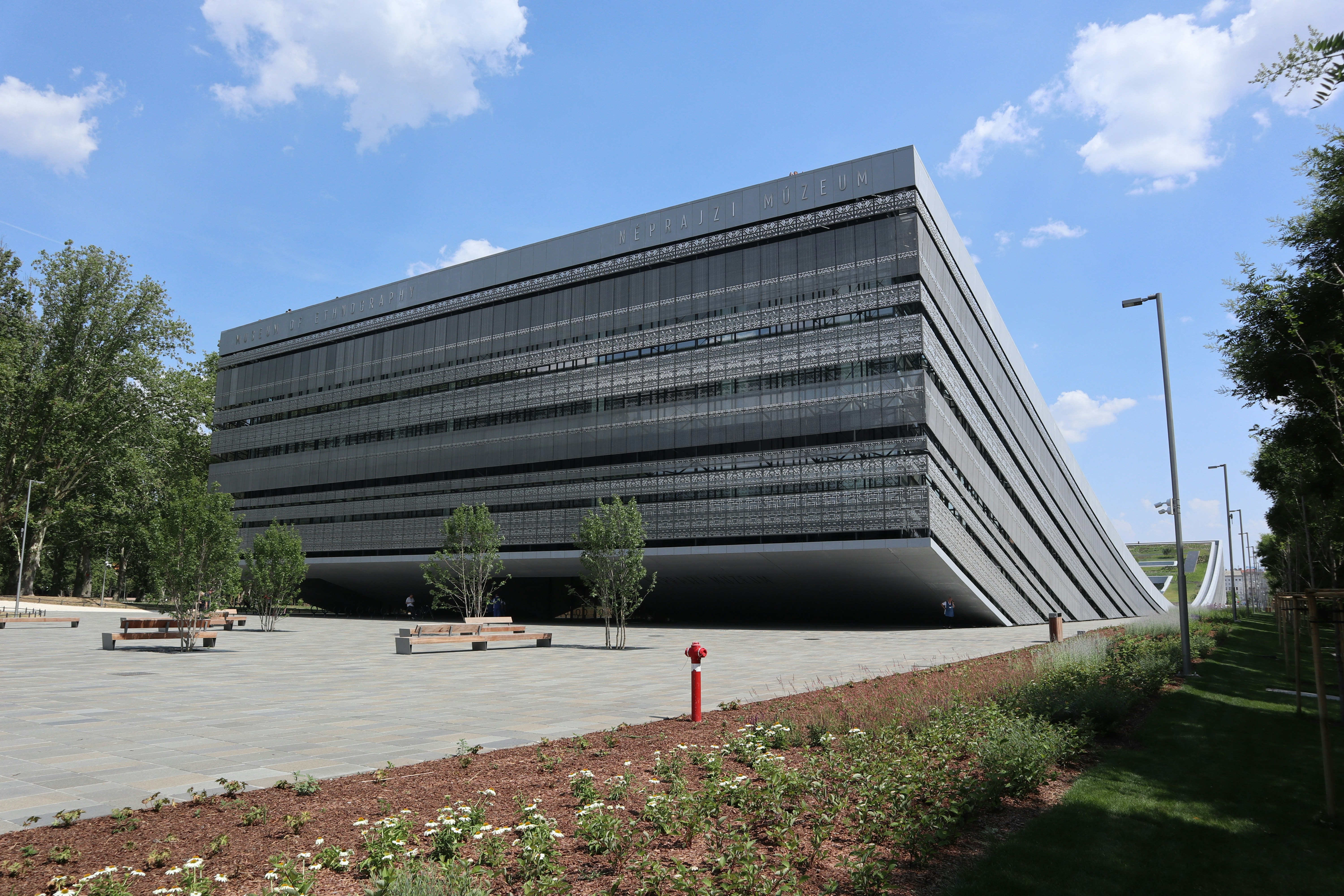 A large black building sitting on the side of a road photo – Free ...