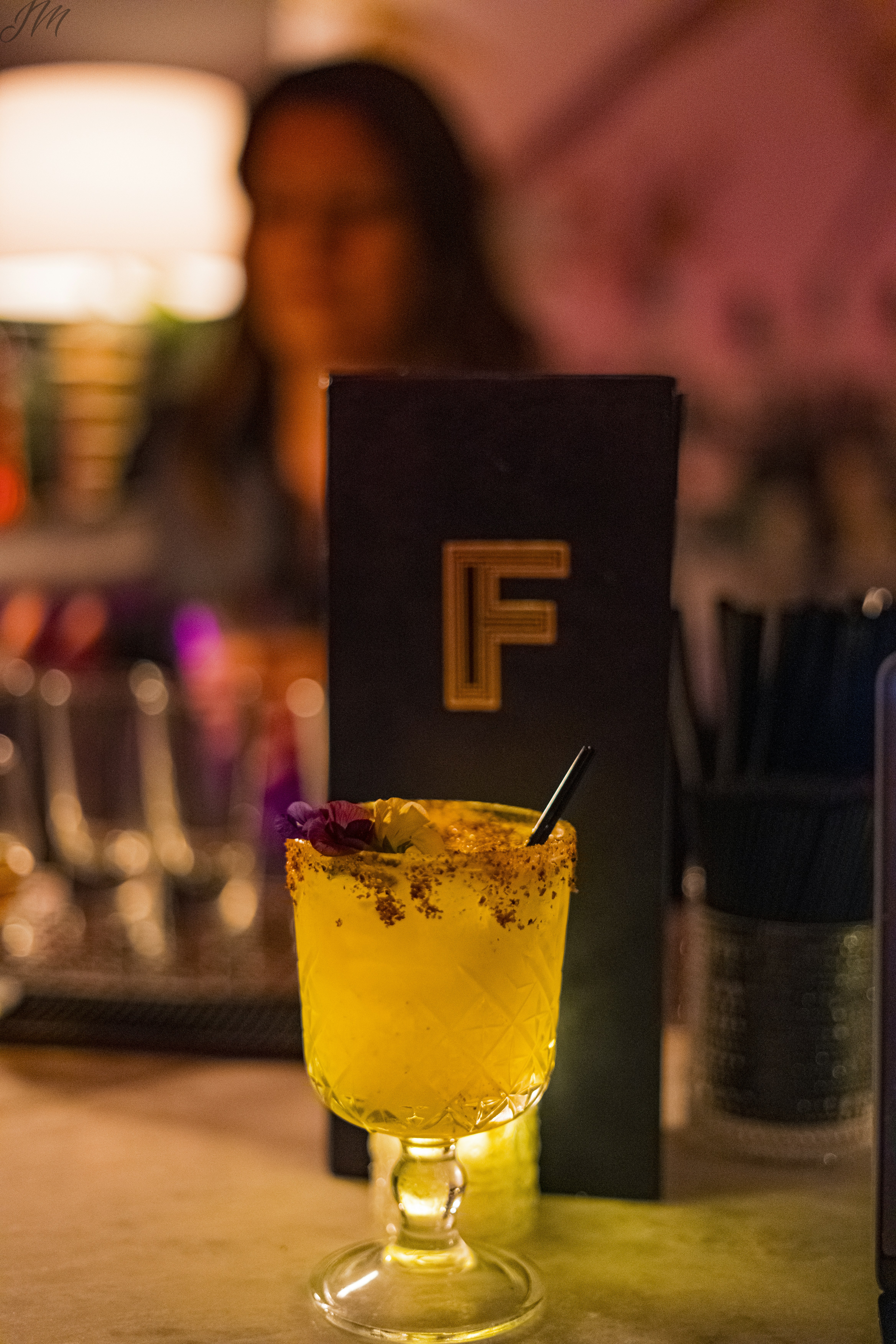Amber Elixir at the Bar: A Glimpse Beyond the Shadowed Bottle