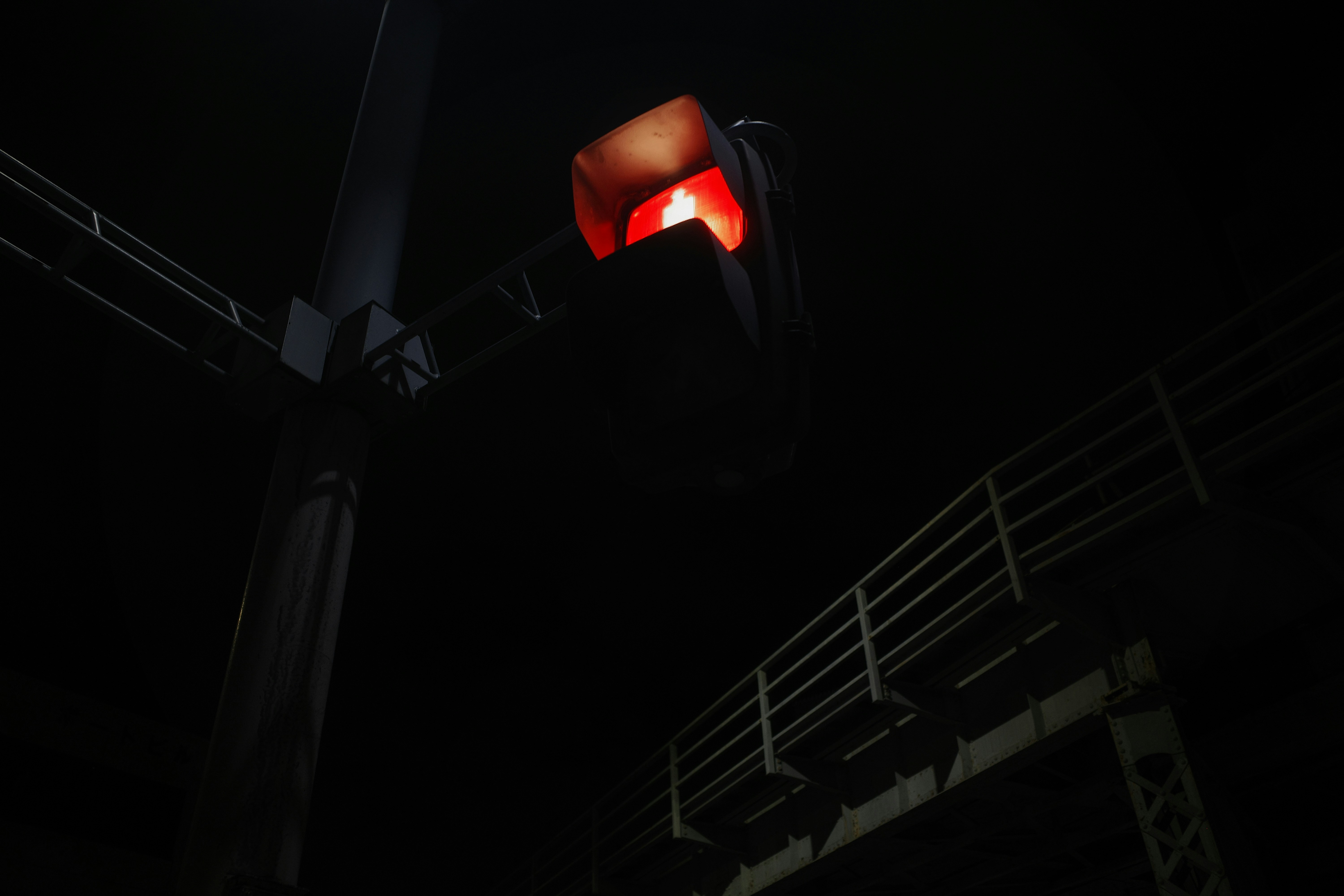 Crimson Signal Over a Silent Industrial Spine at Night