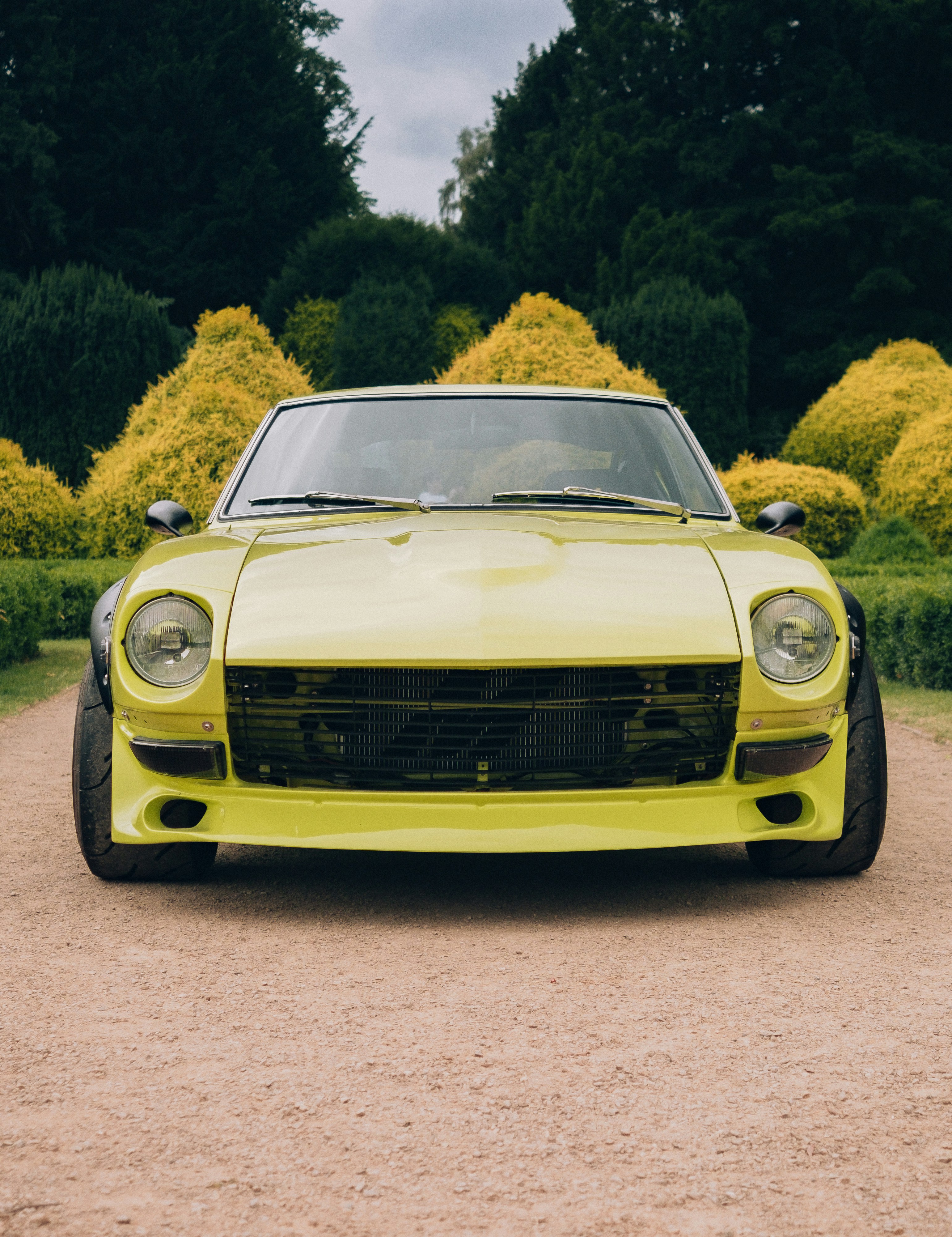 A yellow sports car parked on a gravel road photo – Free Uk Image on ...