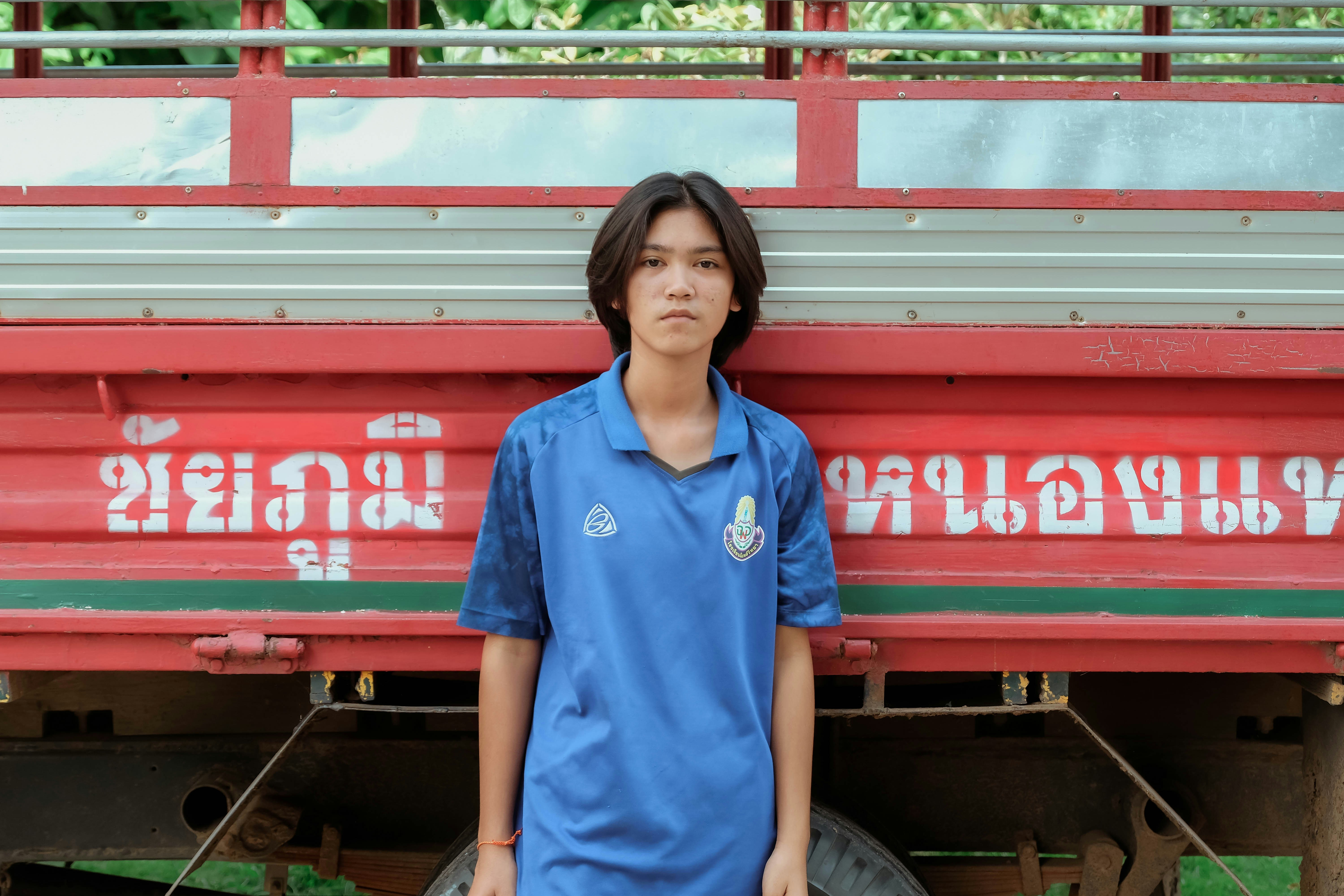 A woman standing in front of a red truck photo – Free Portrait Image on ...