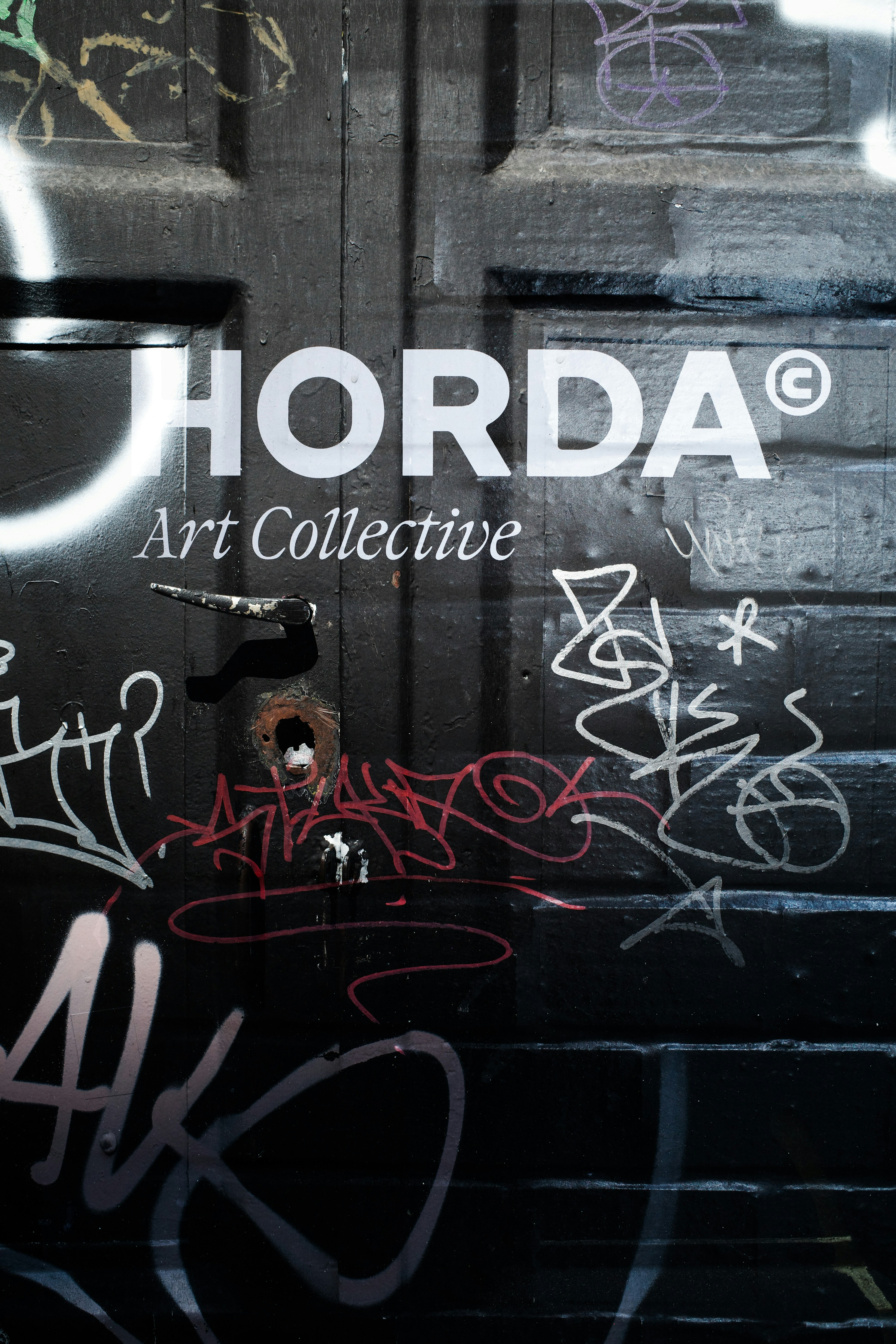 A door with a bunch of graffiti on it photo – Free Budapest Image on ...
